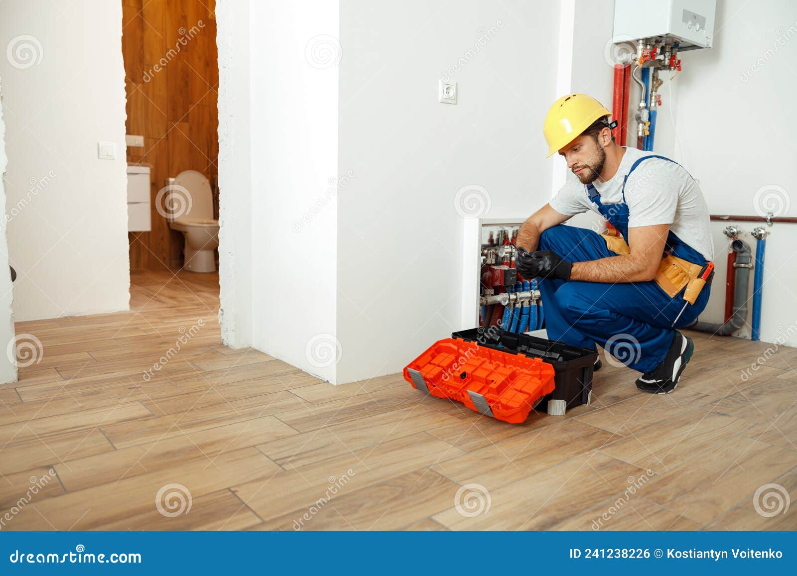 Busy Technician, Plumber in Protective Gloves Using Tools from Toolbox ...