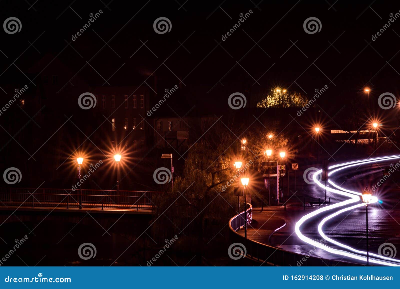 Busy village road at night stock photo. Image of lamp - 162914208