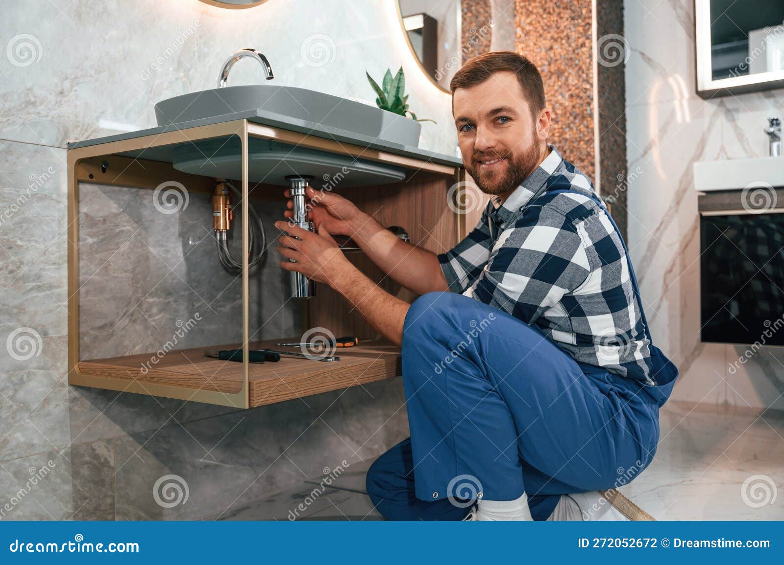 Busy Worker in Blue Uniform is in the Bathroom Stock Photo - Image of ...