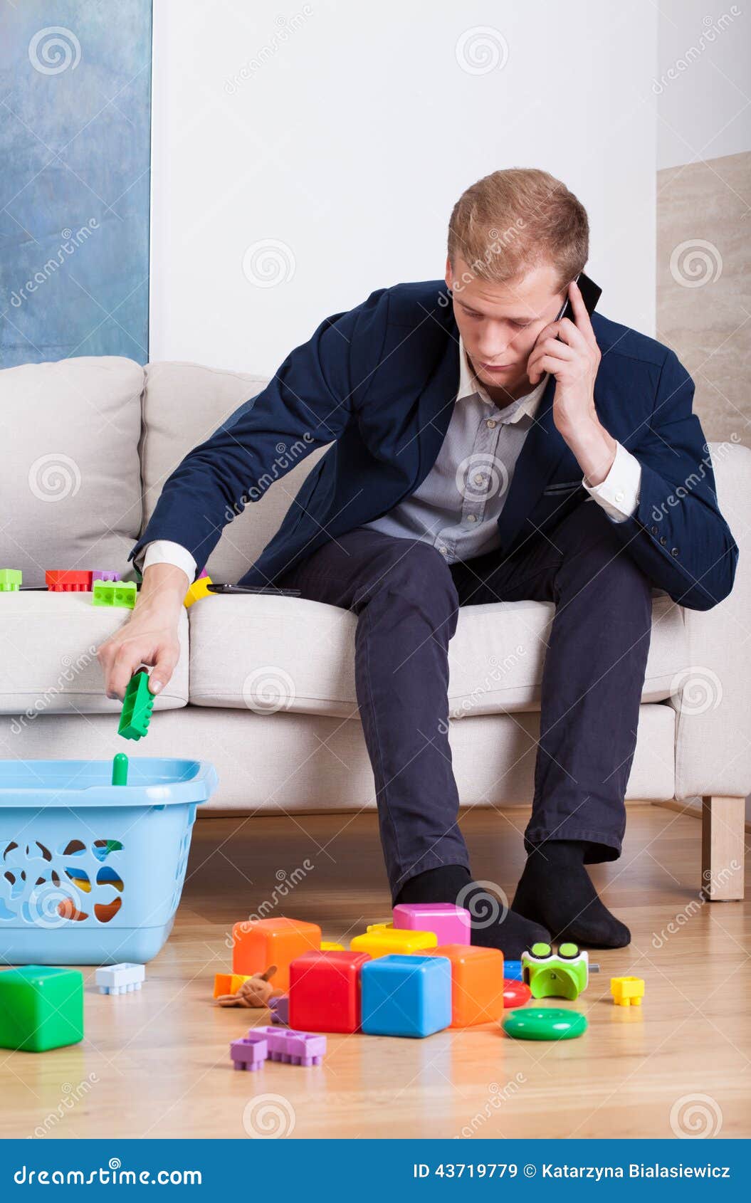 Busy young dad cleans toys stock image. Image of male - 43719779