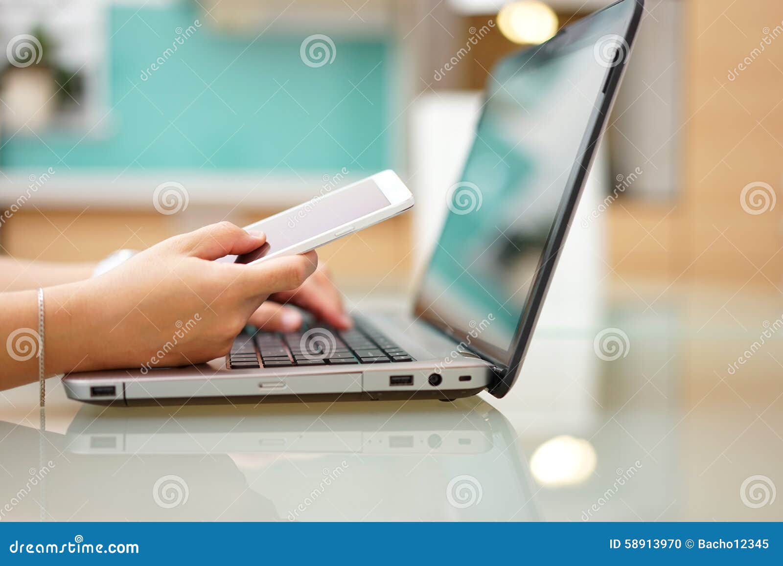 Busy Young Woman is Typing on Laptop Computer and Using Mobile P Stock ...