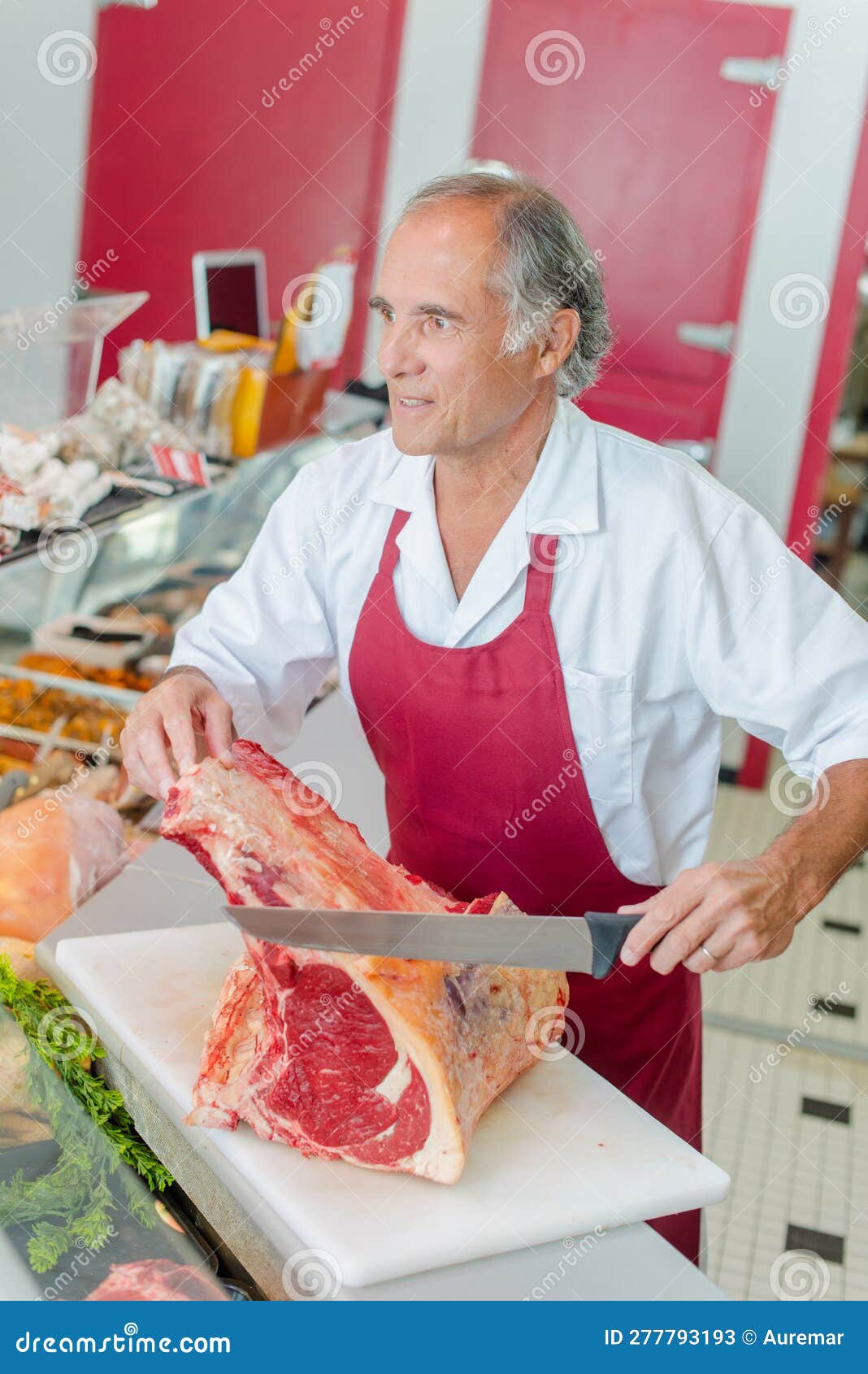 Butcher cutting meat stock image. Image of left, service - 277793193