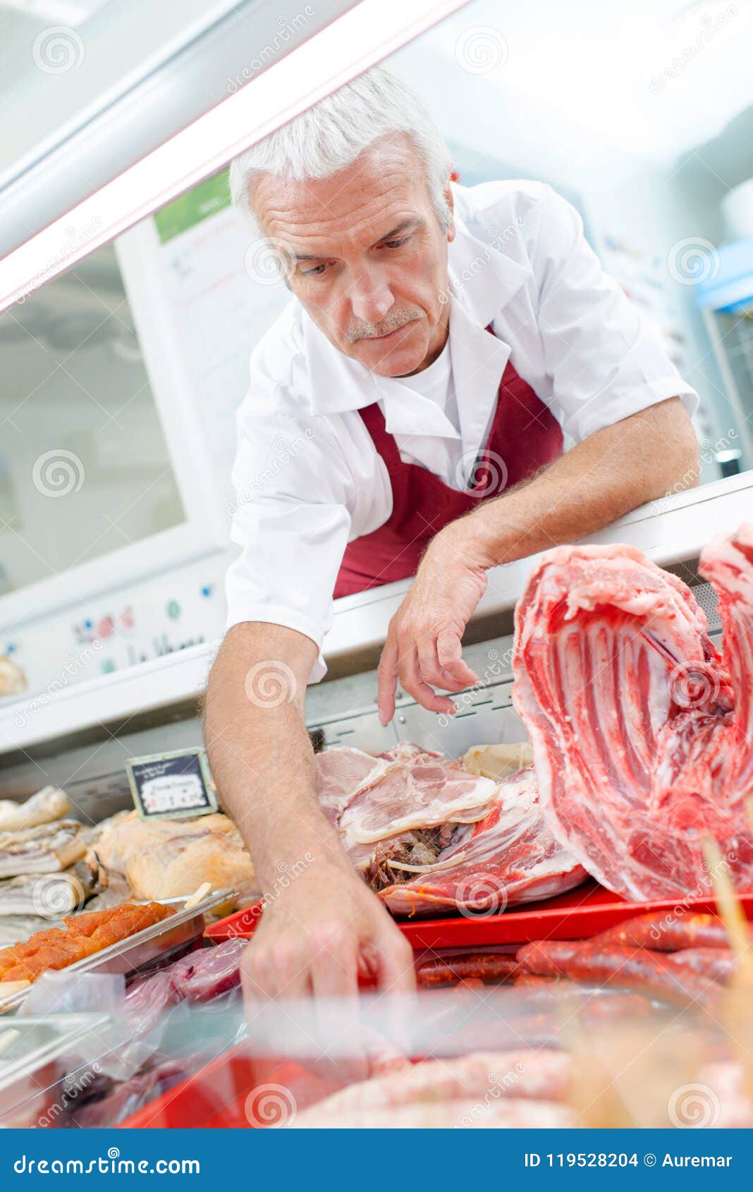 Butcher Reaching into Counter Stock Photo - Image of senior, butcher ...