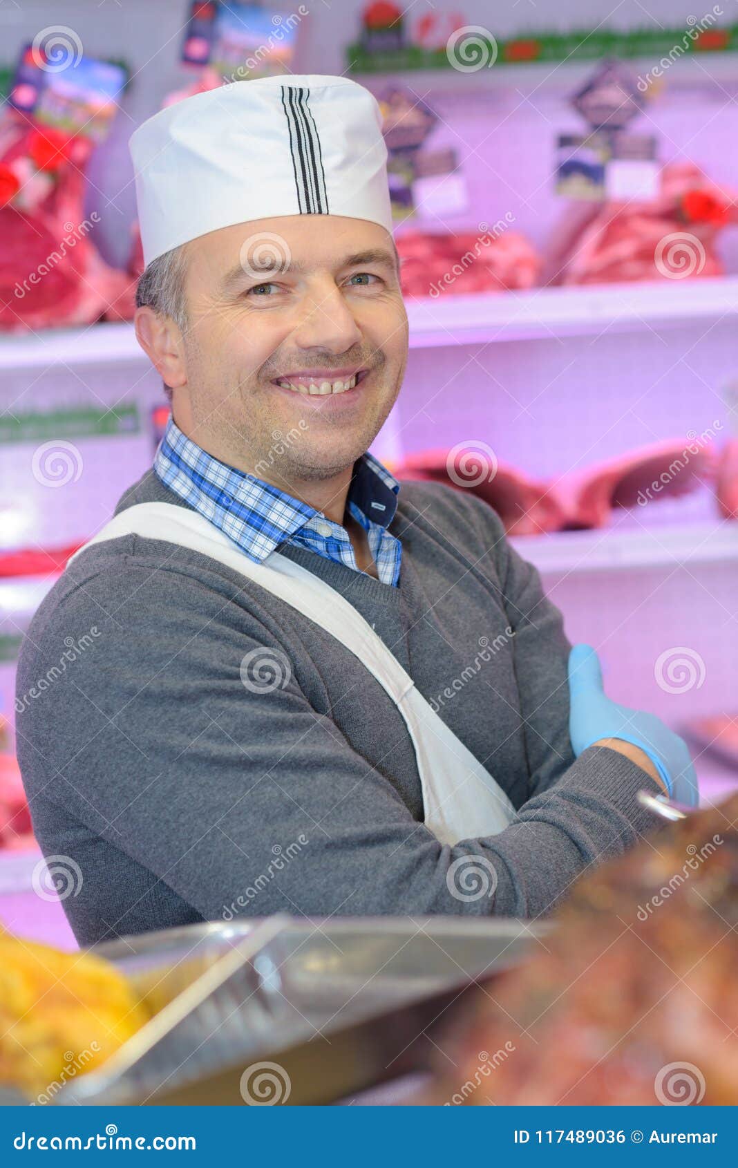 Butcher smiling and posing stock photo. Image of service - 117489036