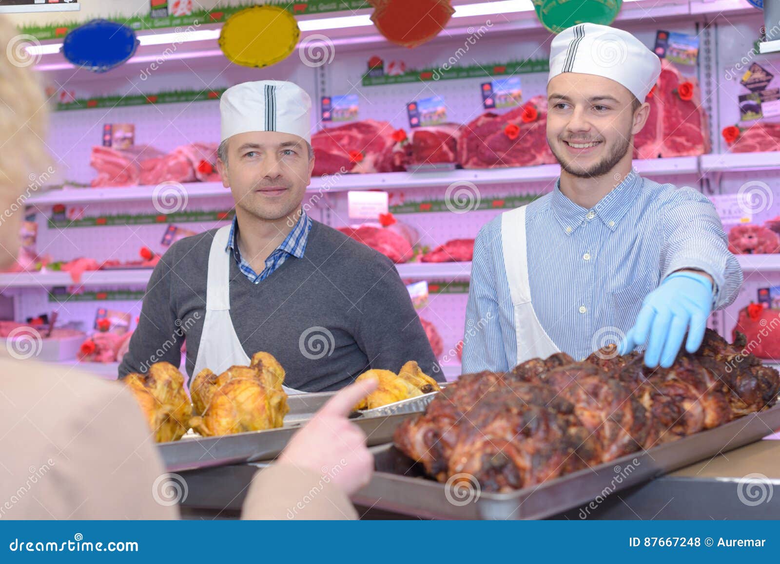 Butcher Teaching Young One How To Sell Meat Stock Photo - Image of ...