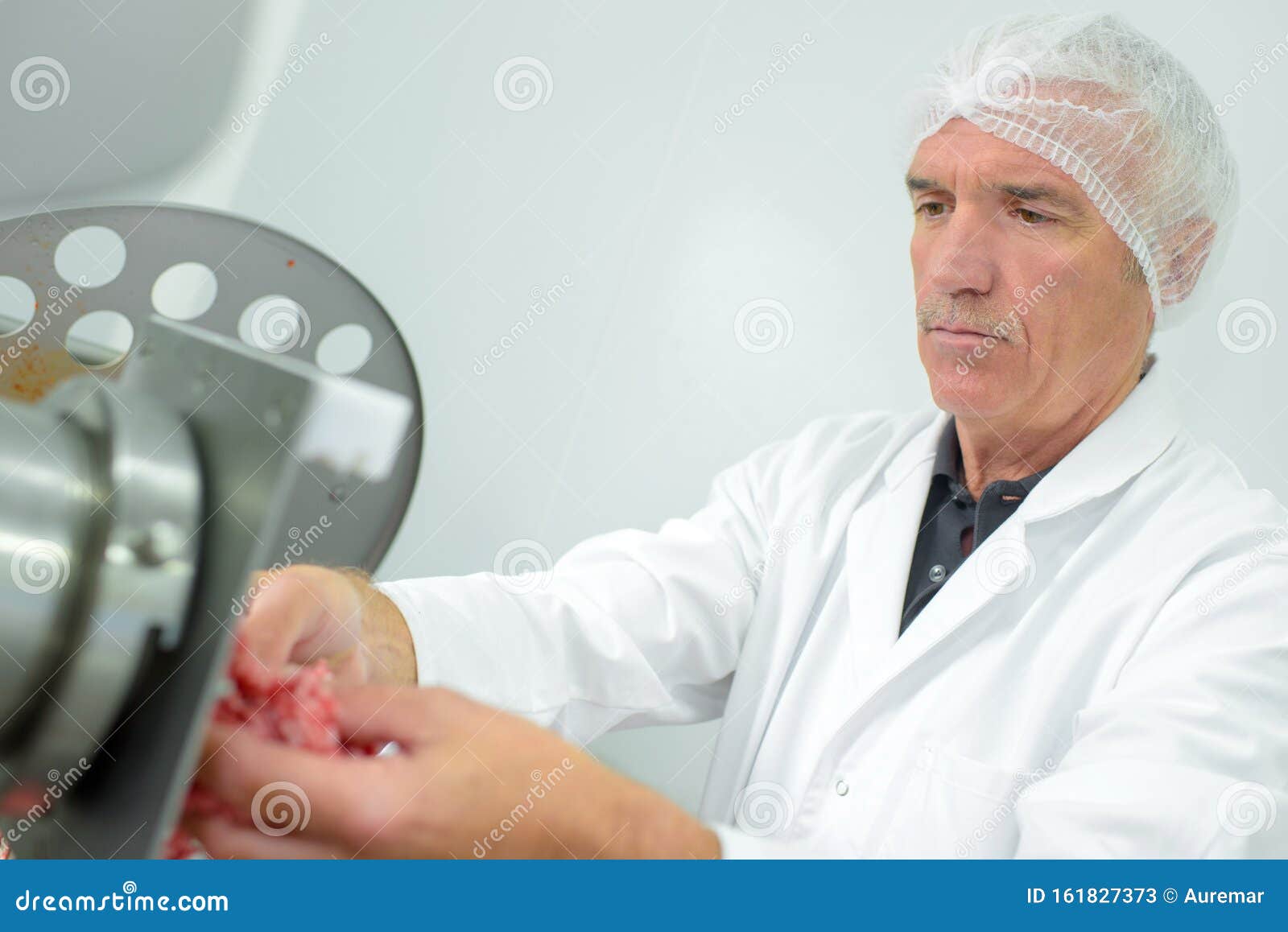 Butcher using meat grinder stock image. Image of middle - 161827373