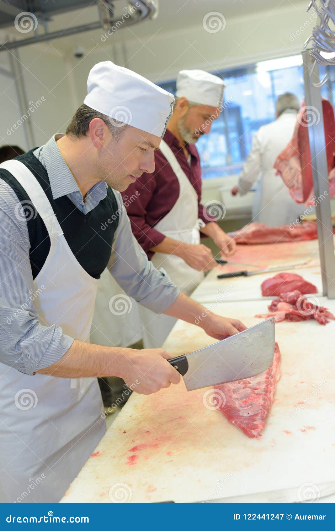 Two Butchers Cutting Meat In Butchery Royalty-Free Stock Image ...