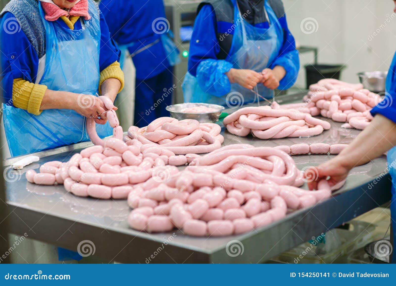 Butchers Processing Sausages at a Meat Factory. Stock Image - Image of ...