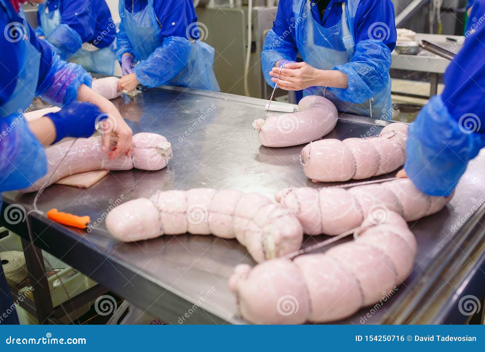 Butchers Processing Sausages at a Meat Factory. Stock Photo - Image of ...