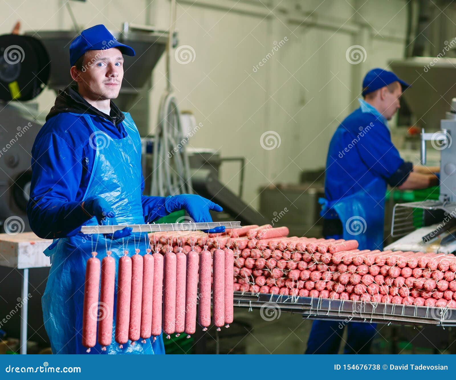 Butchers Processing Sausages at a Meat Factory. Stock Photo - Image of ...