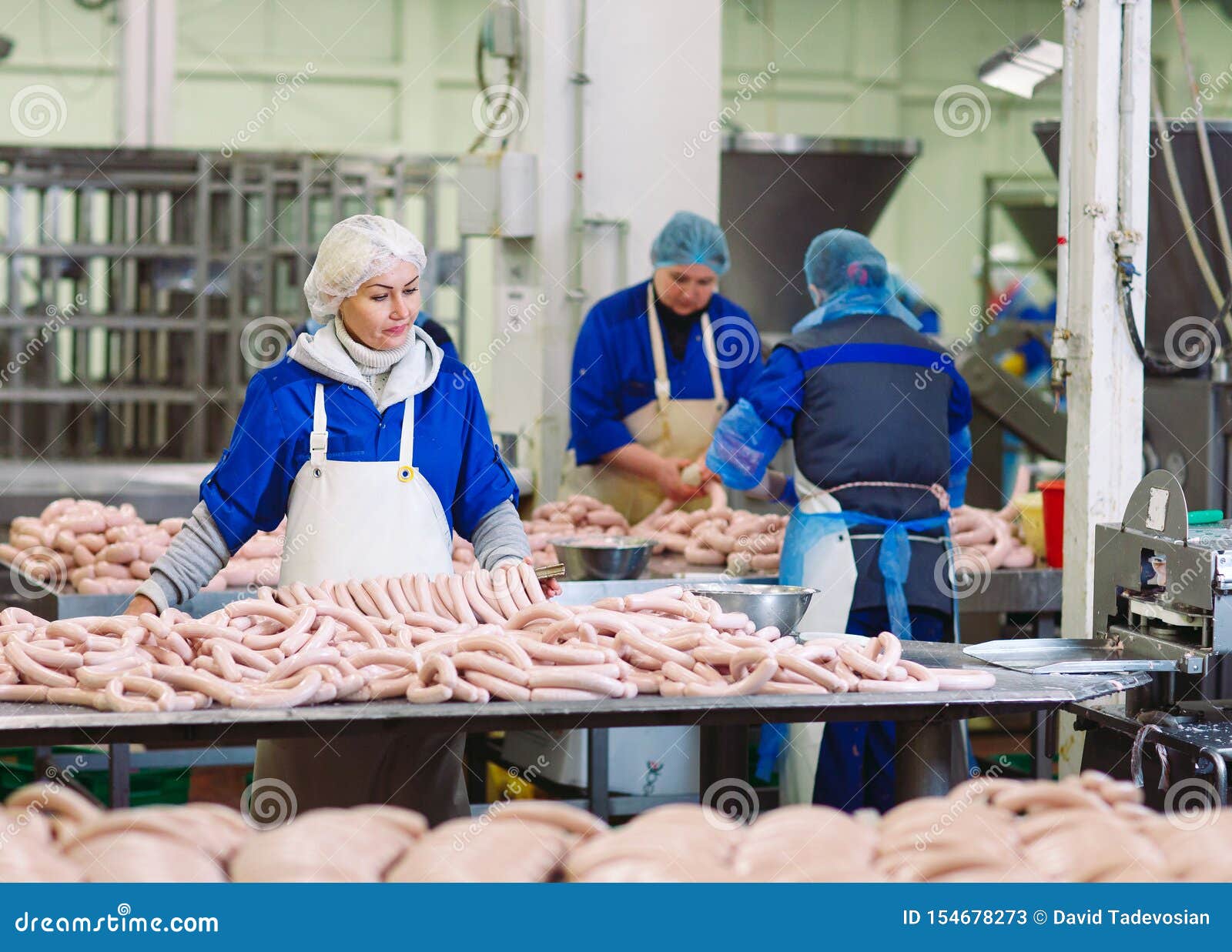 Butchers Processing Sausages at a Meat Factory. Stock Image - Image of ...