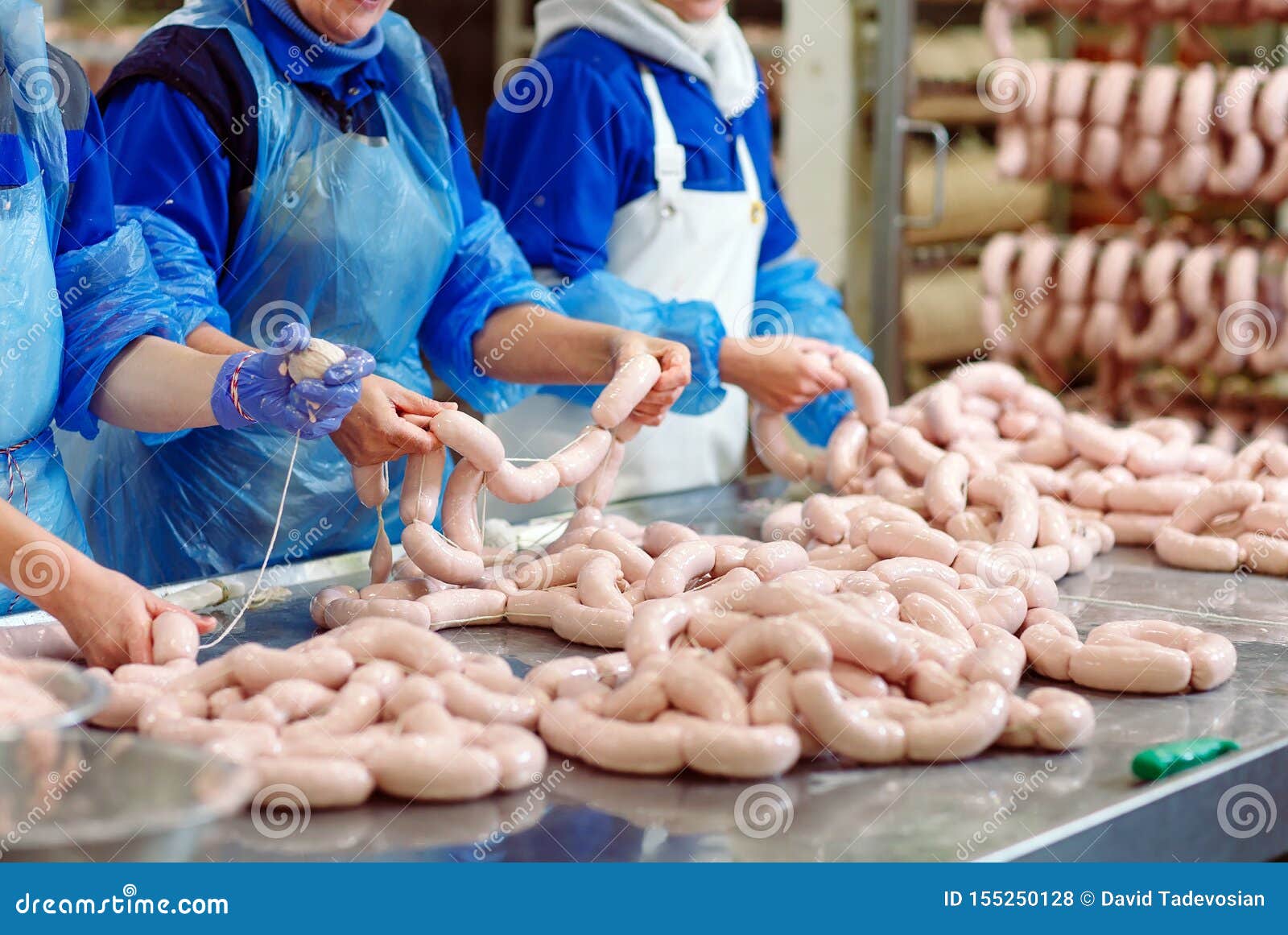 Butchers Processing Sausages at the Meat Factory. Stock Photo - Image ...