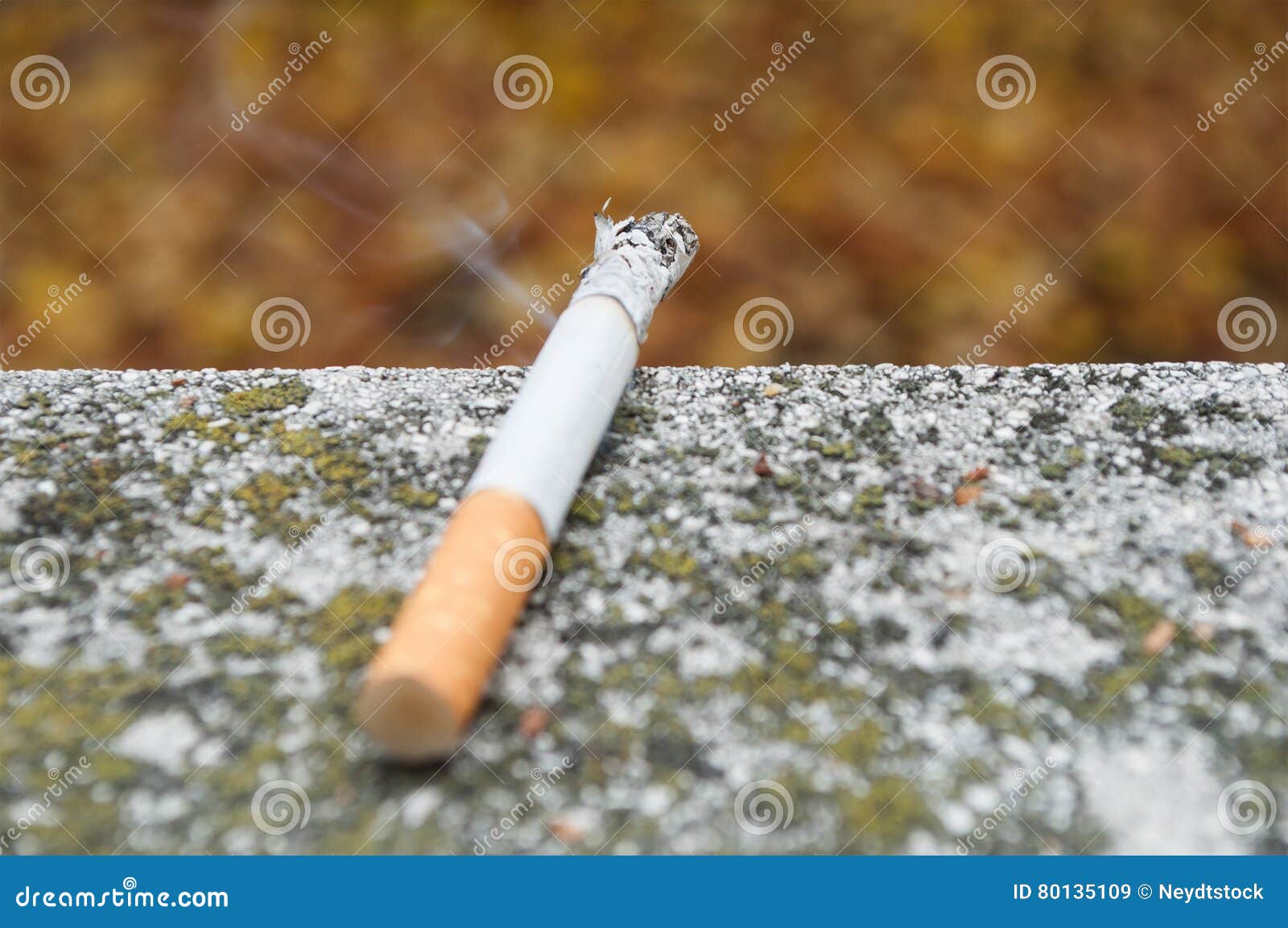 Lit Cigarette Resting on a Wall Stock Image - Image of health, tobacco ...