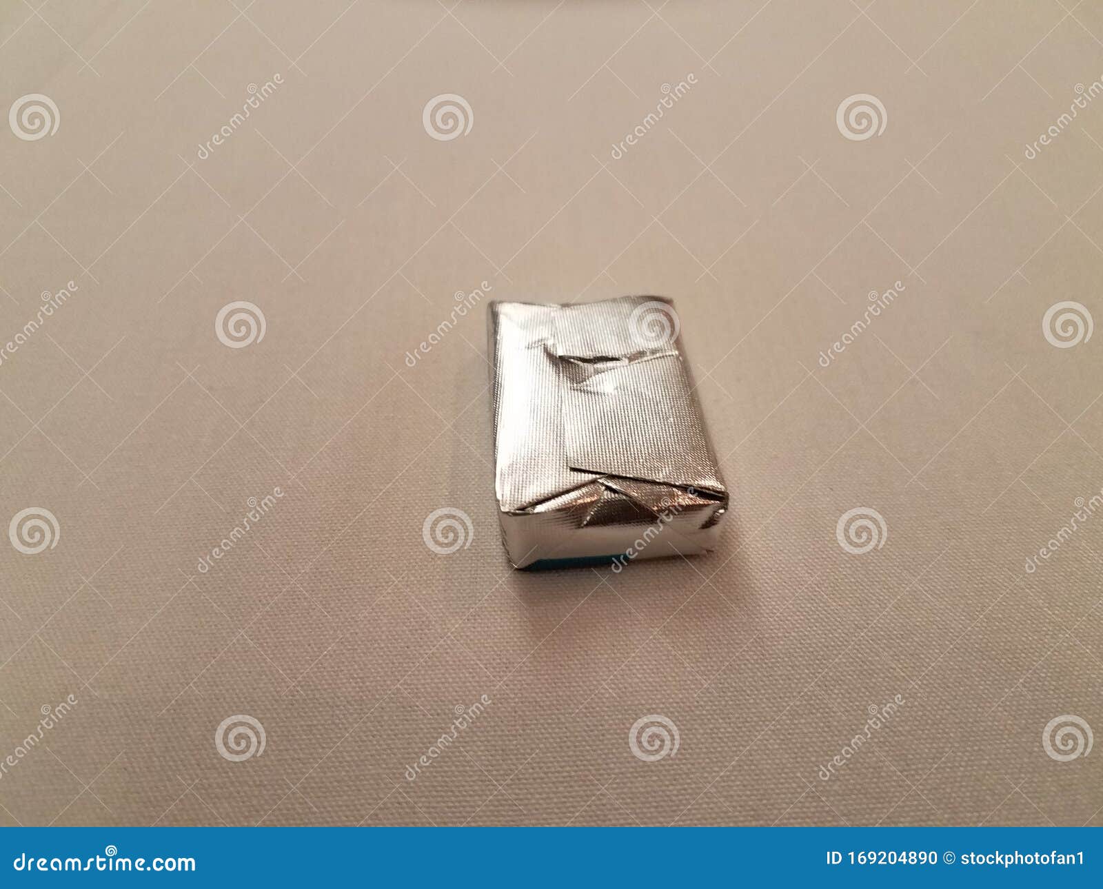 Butter in Silver Foil Wrapper on Surface or Table Stock Photo - Image ...