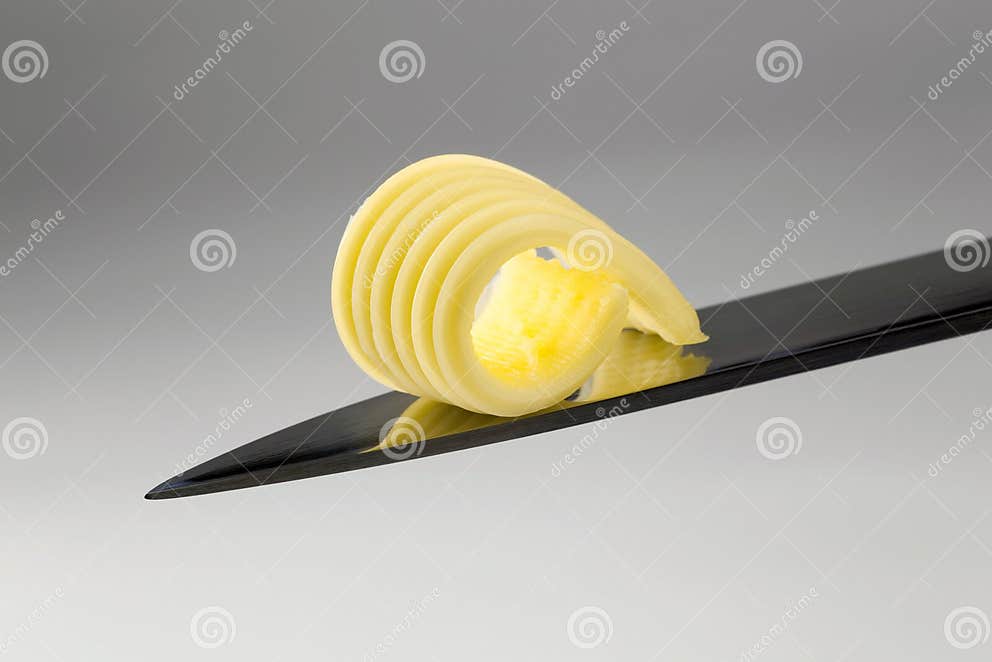 Butter curl on a knife stock photo. Image of curl, butter - 10451182