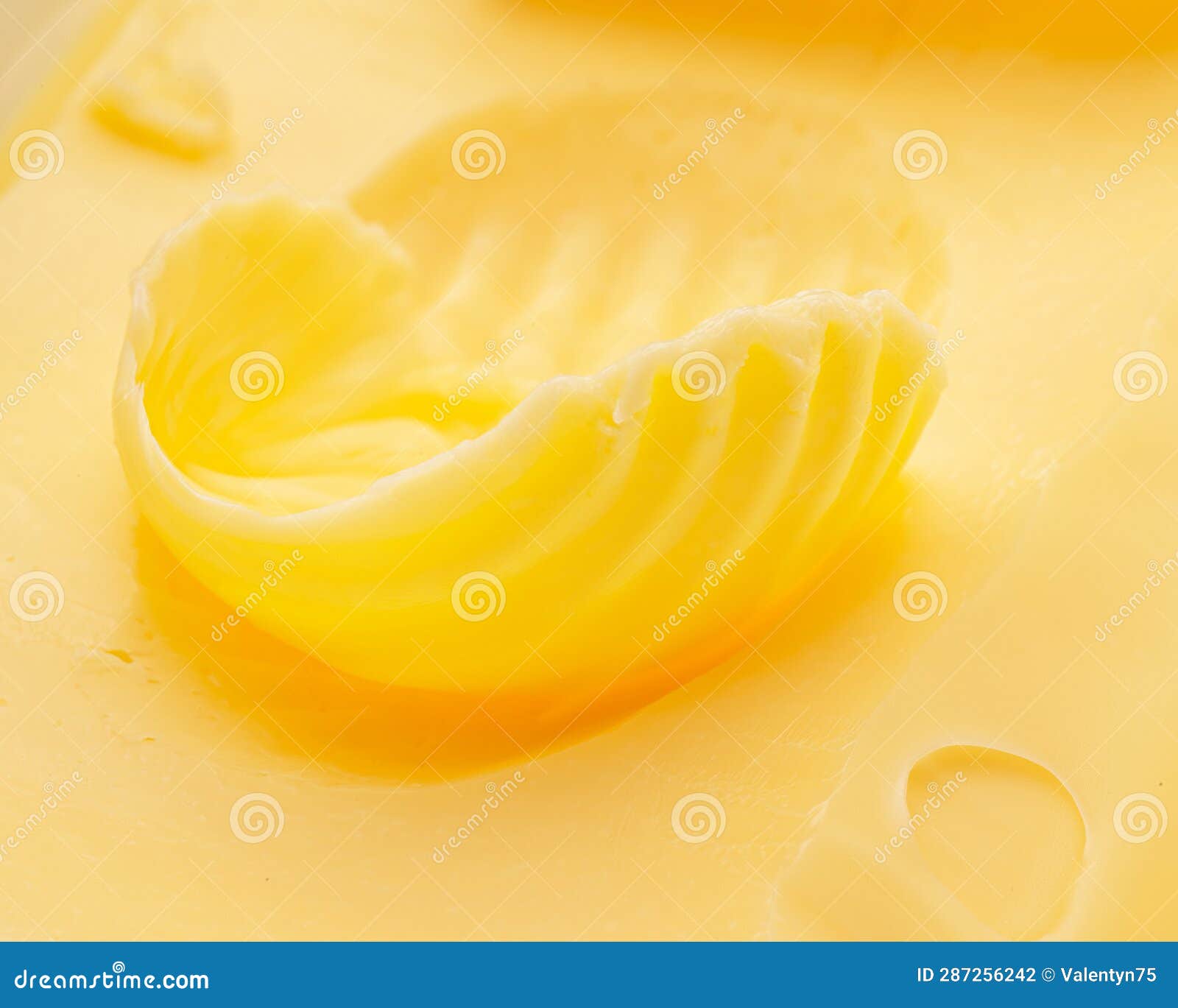 Butter Curl Over the Piece of the Butter Closeup. Food Background Stock ...