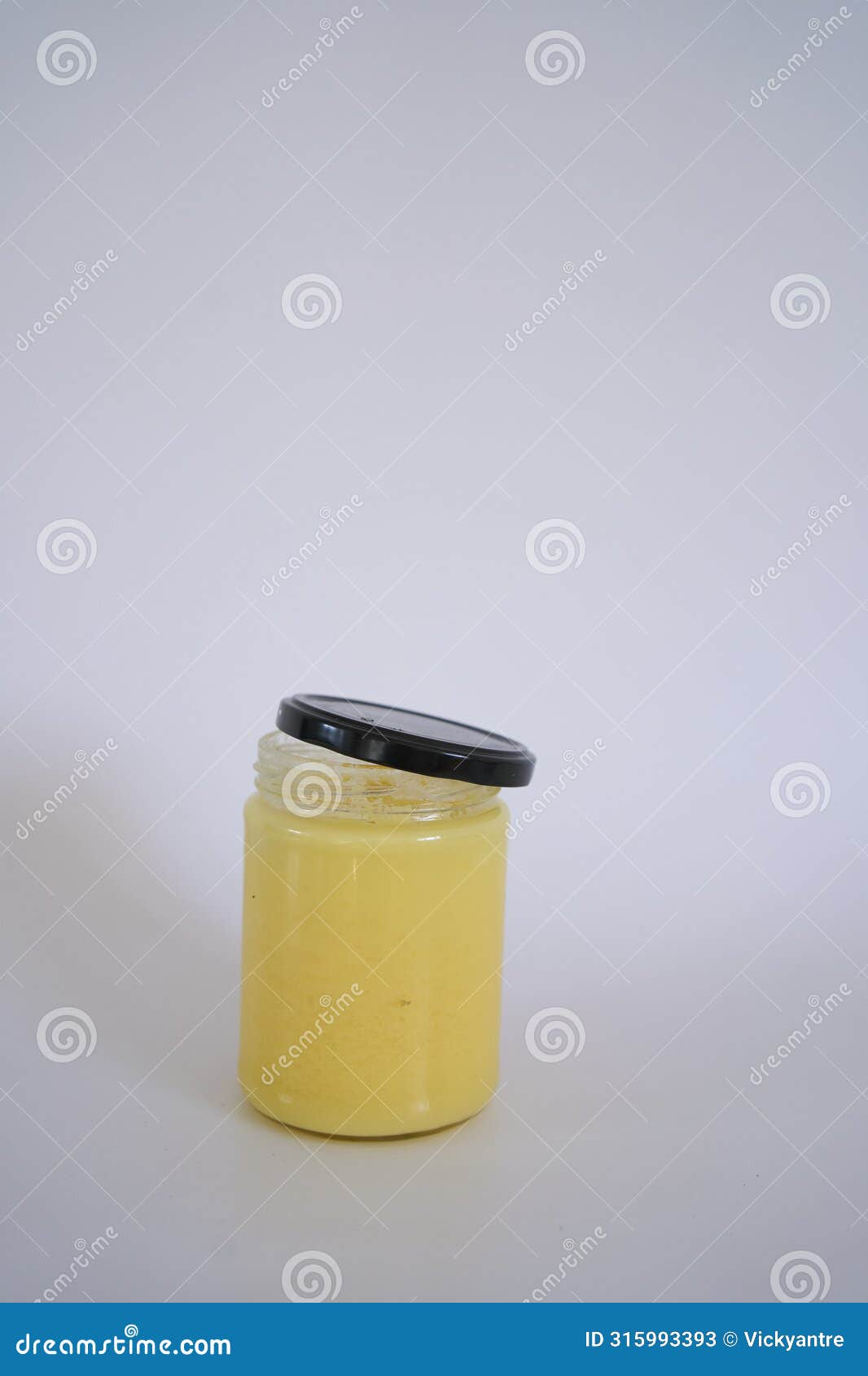 Butter Ghee in a Transparent Jar with Homemade Bread on a White ...