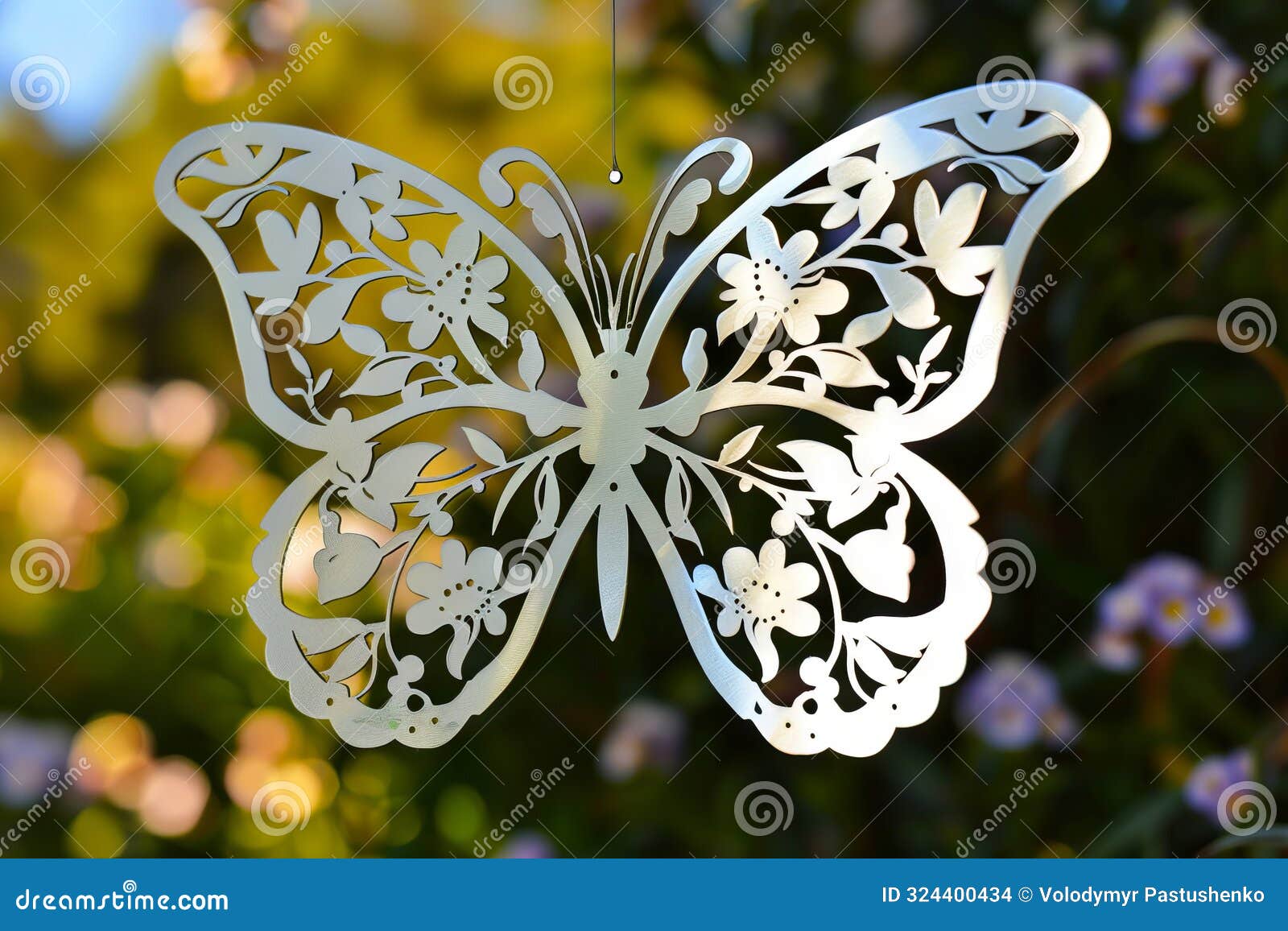 A Butterfly Hanging from a String in the Garden Stock Photo - Image of ...