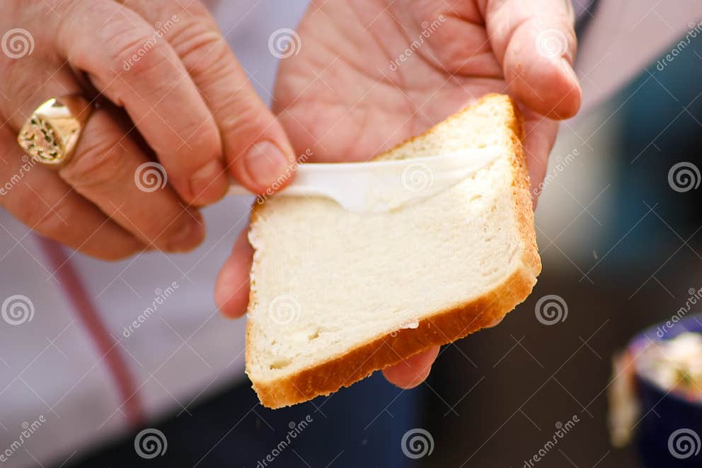 Buttering a slice of bread stock image. Image of hands - 14258979