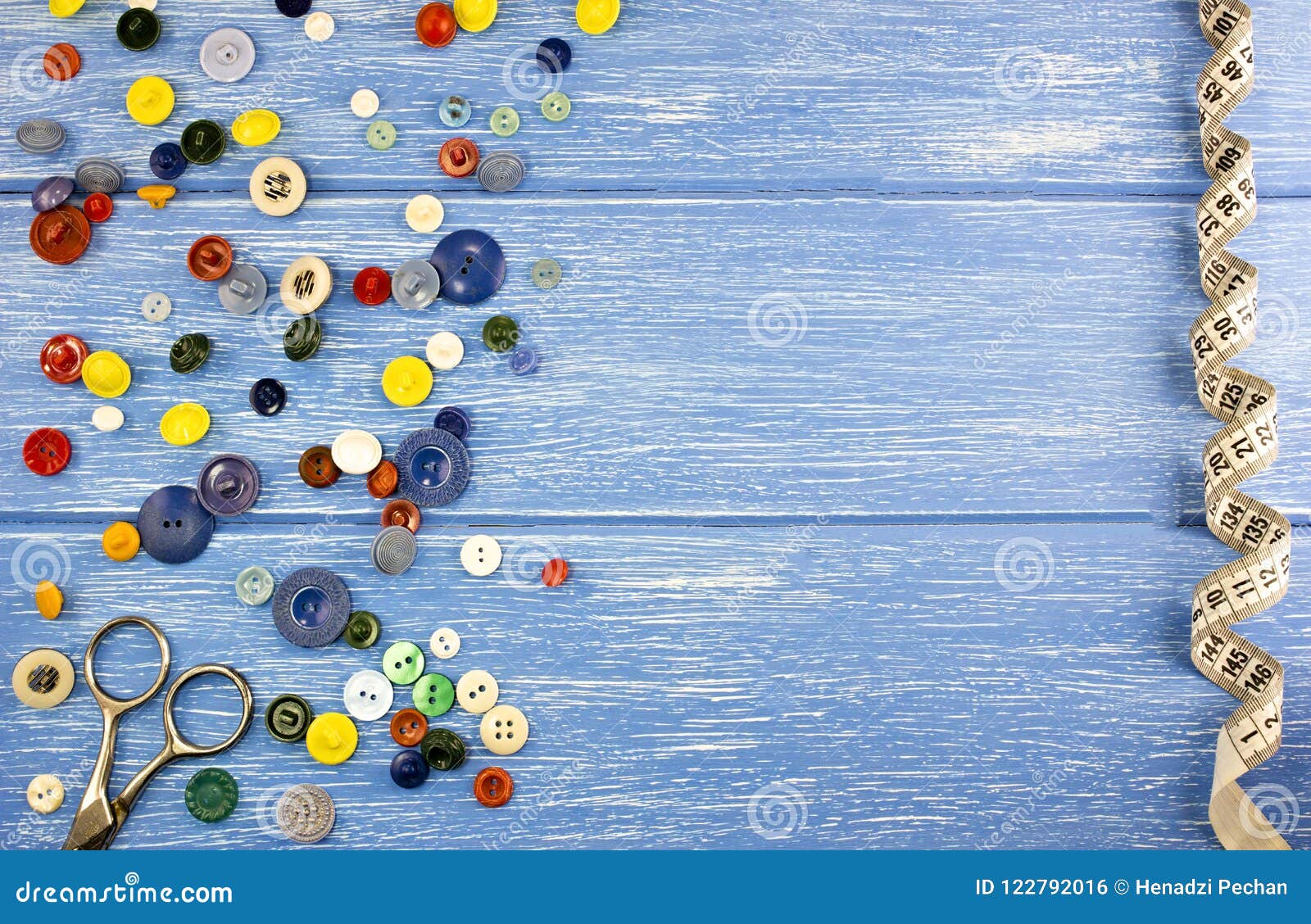 Buttons Scissors and Centimeter Tape on a Blue Background Dressmaking ...