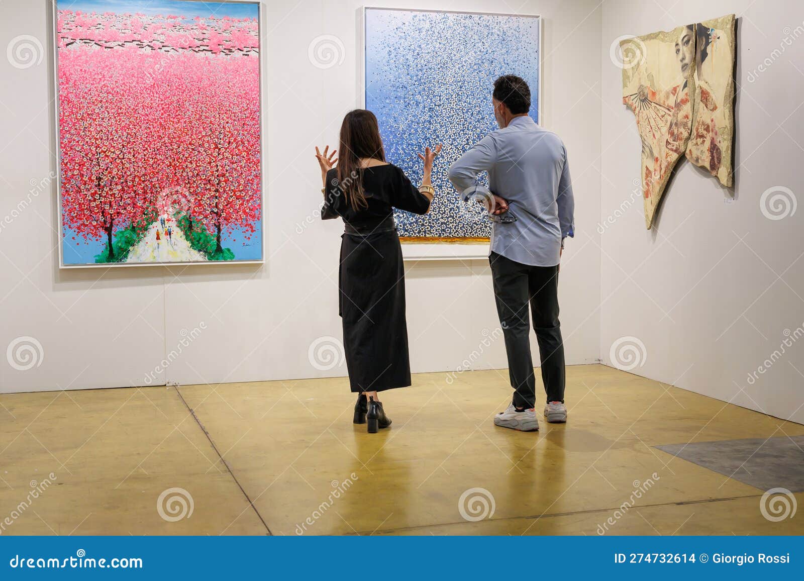 Buyer Evaluating the Purchase of Works in a Modern Art Gallery Stock ...