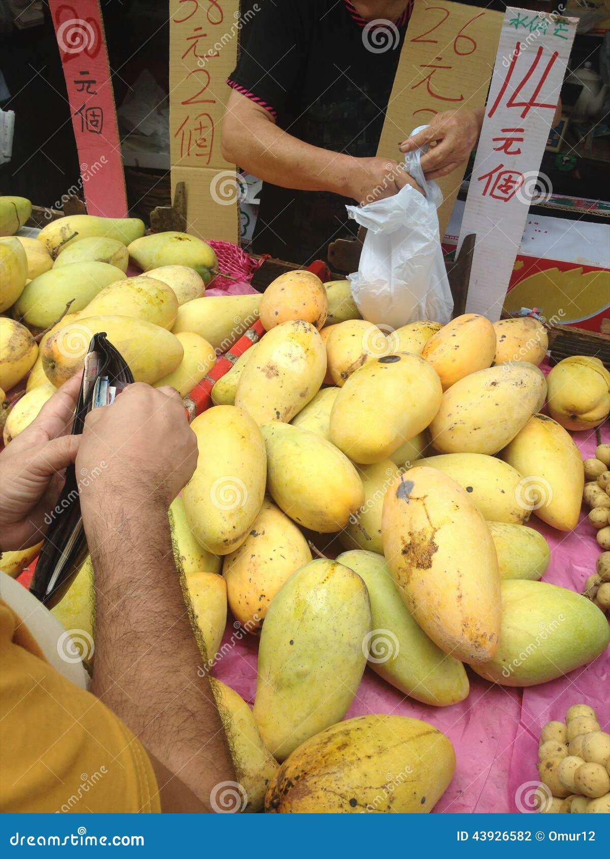 Buyer pays money for mango stock photo. Image of grocery - 43926582