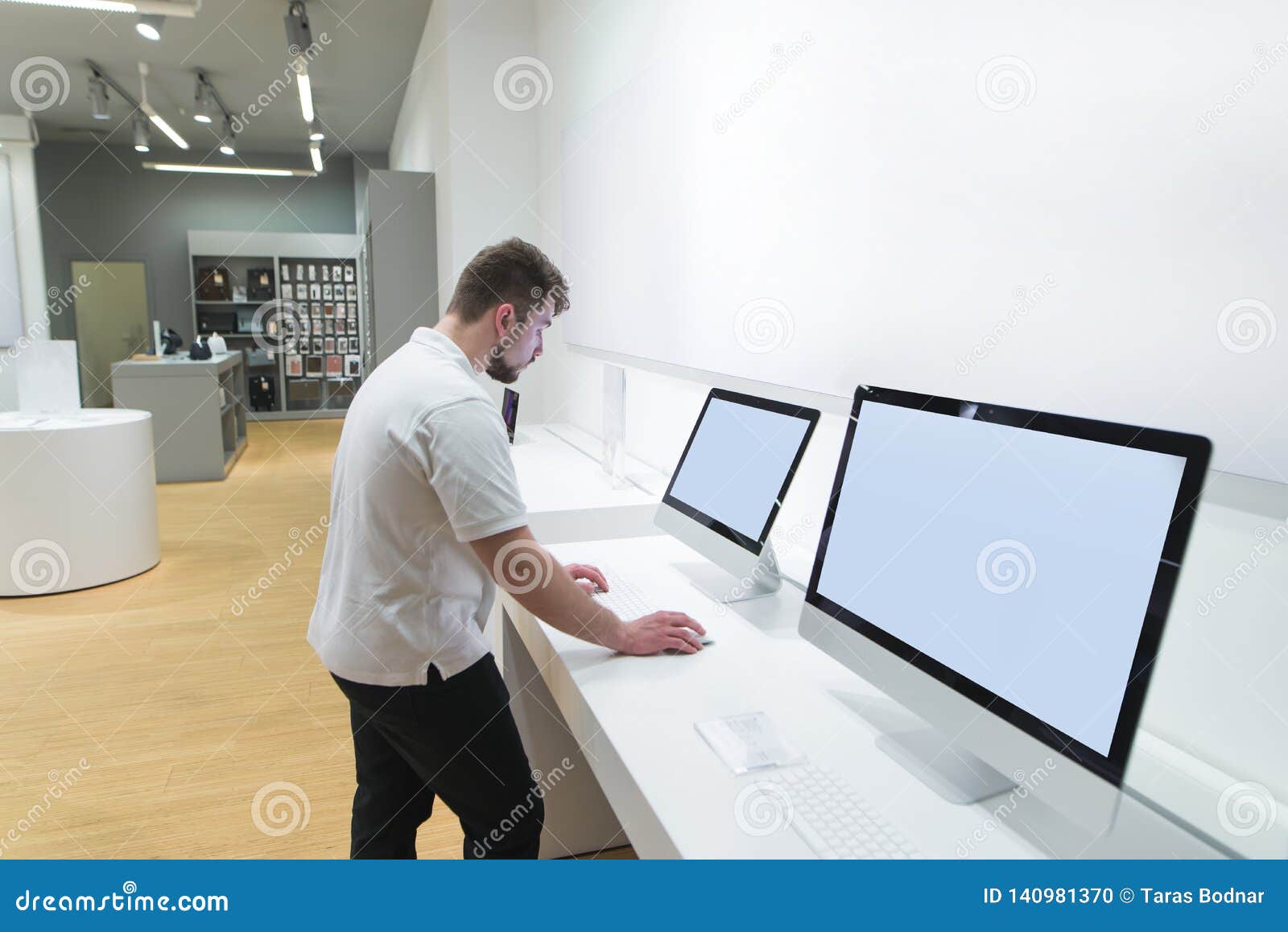 Buyer Uses a Monoblock Computer in a Modern Technology Store. Man with ...