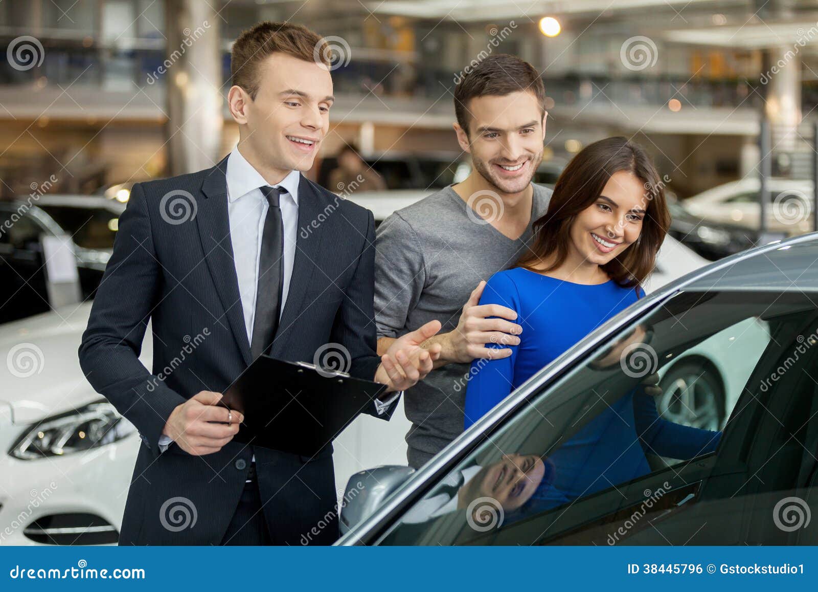 Buying Their First Car Together. Stock Photo - Image of examining ...