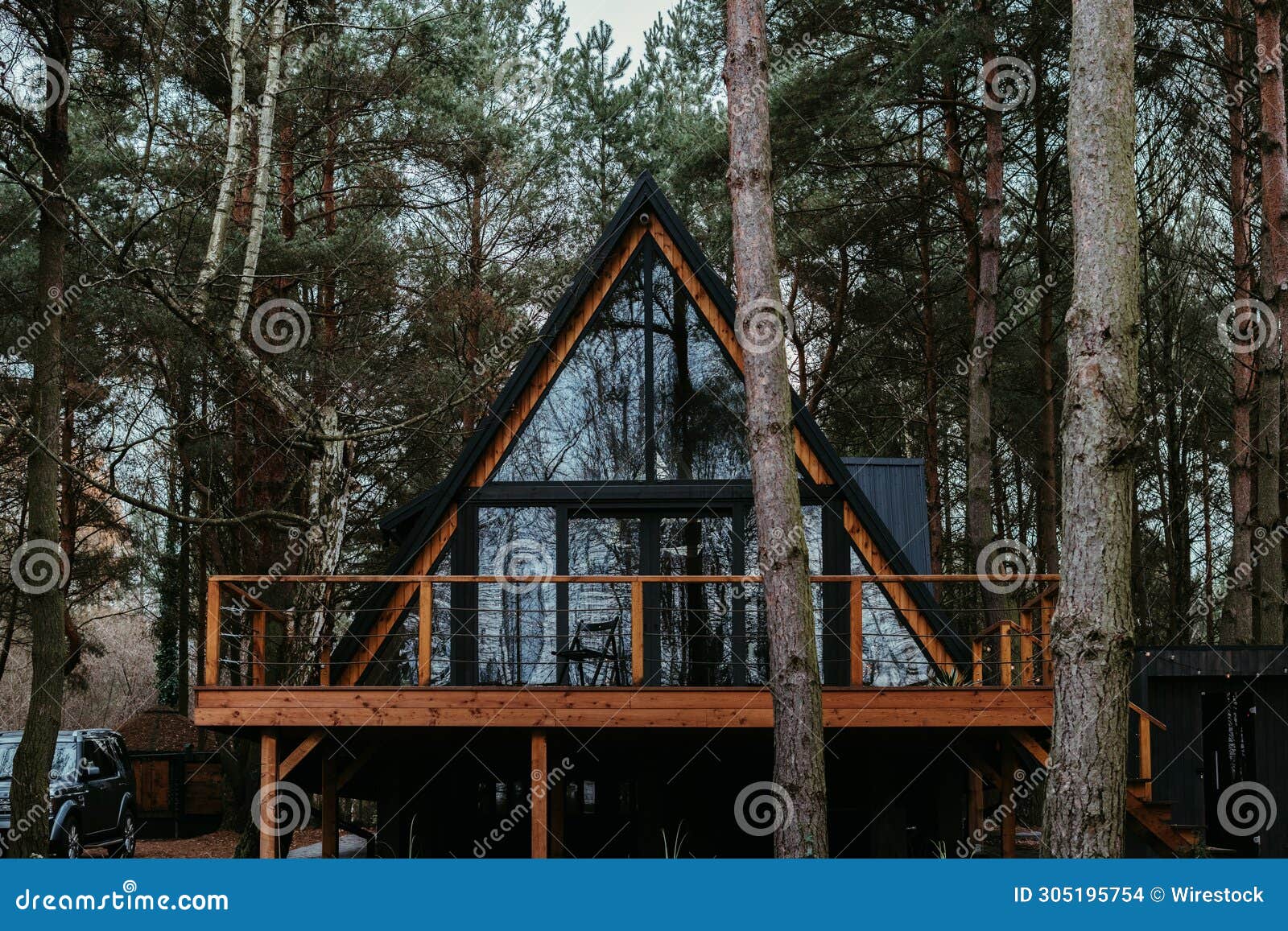 Modern Wooden Cabin in the Forest Surrounded by Trees Stock Photo ...