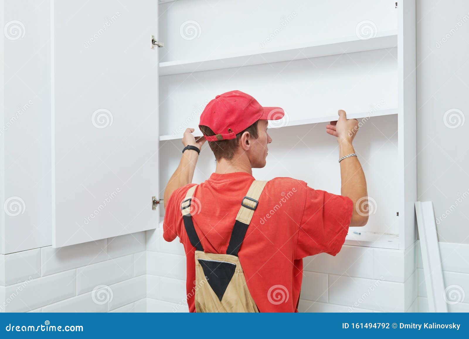 Cabinet Shelf Installation. Worker Assembling Furniture Stock Photo ...