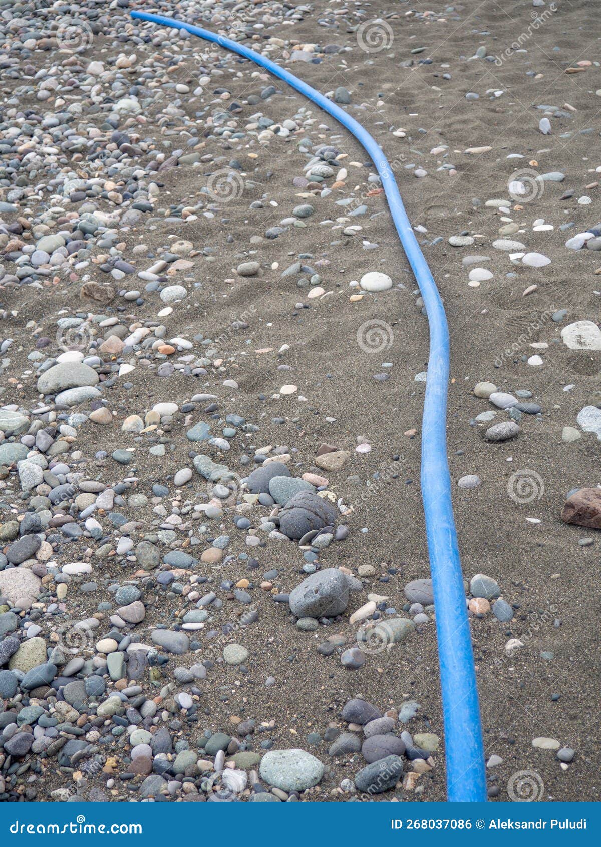 Cable on Black Sand. the Cable Sticks Out of the Ground. Electrical ...