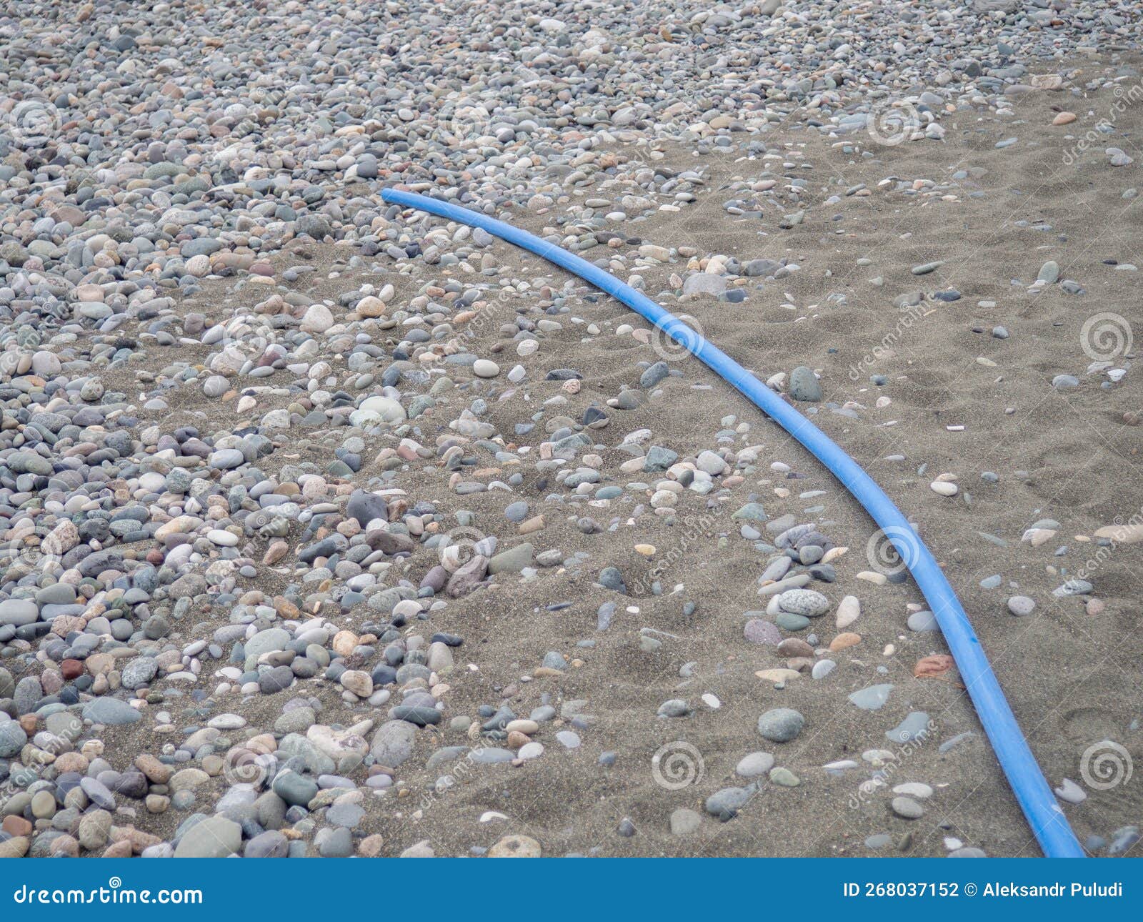 Cable on Black Sand. the Cable Sticks Out of the Ground. Electrical ...