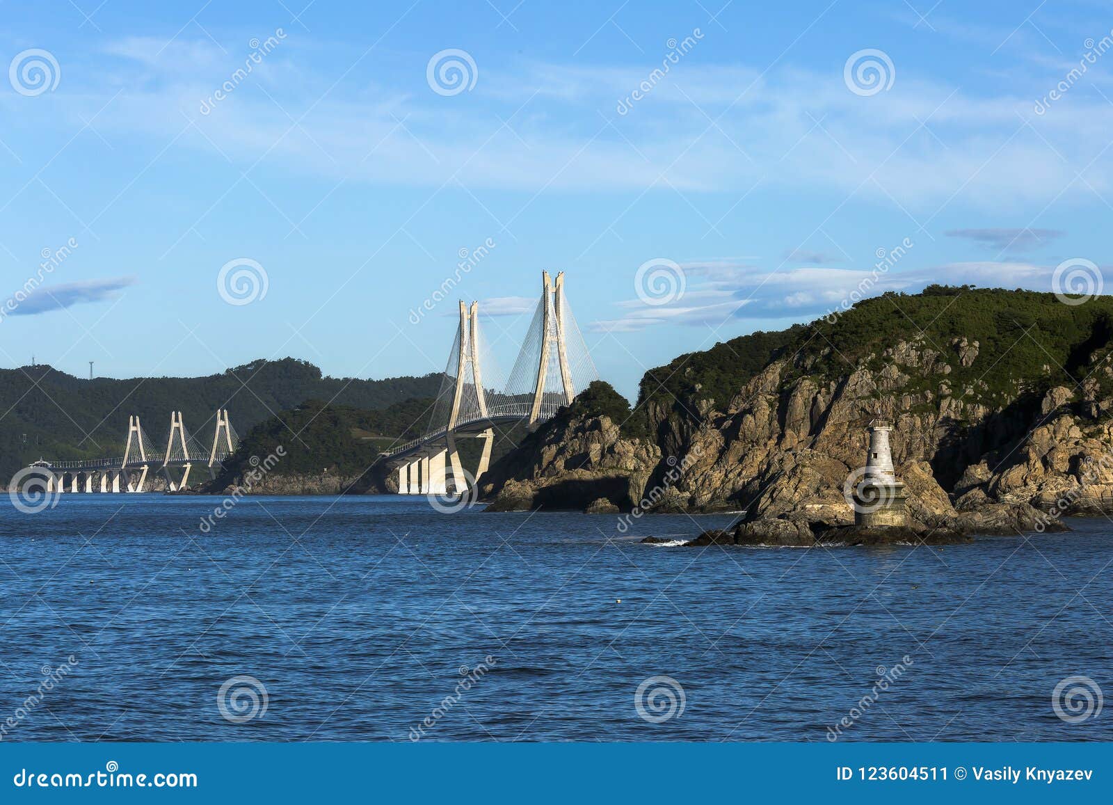 Cable-stayed Bridge To the Island with a Lighthouse on the Rocks Stock ...