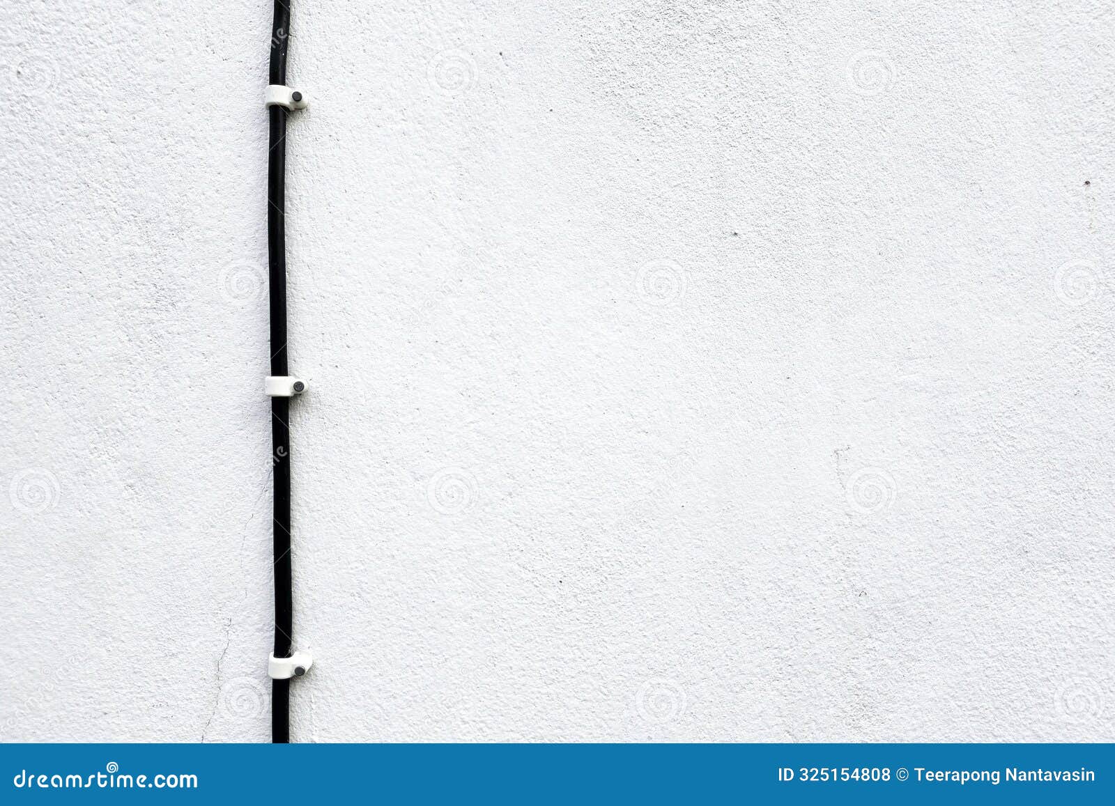 Cable with White Plastic Clips on Concrete Wall Background. Stock Photo ...