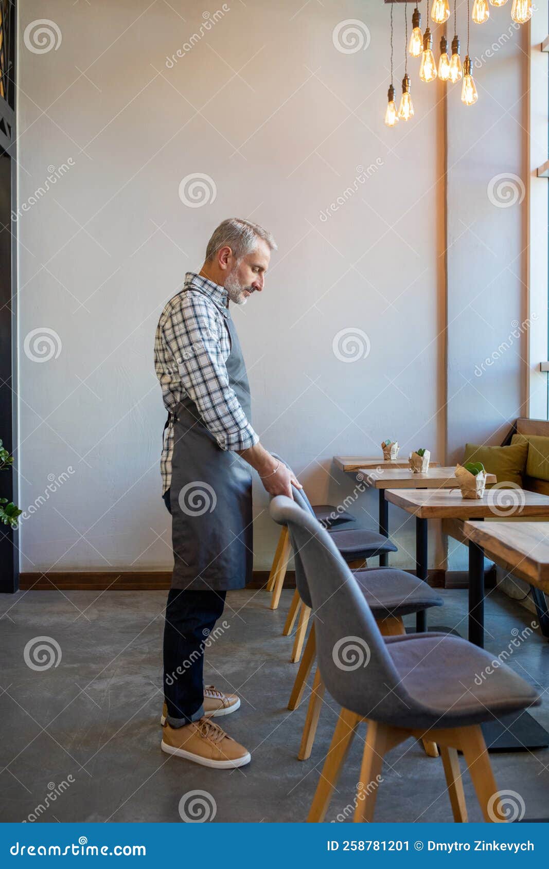 Waiter Putting Chairs in Order in the Cafe Premises Stock Image - Image ...