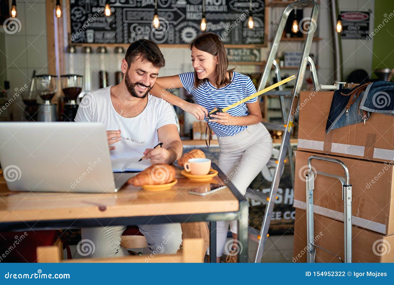Cafe Managers Working on Laptop Ready To Open Their Cafe Stock Photo ...