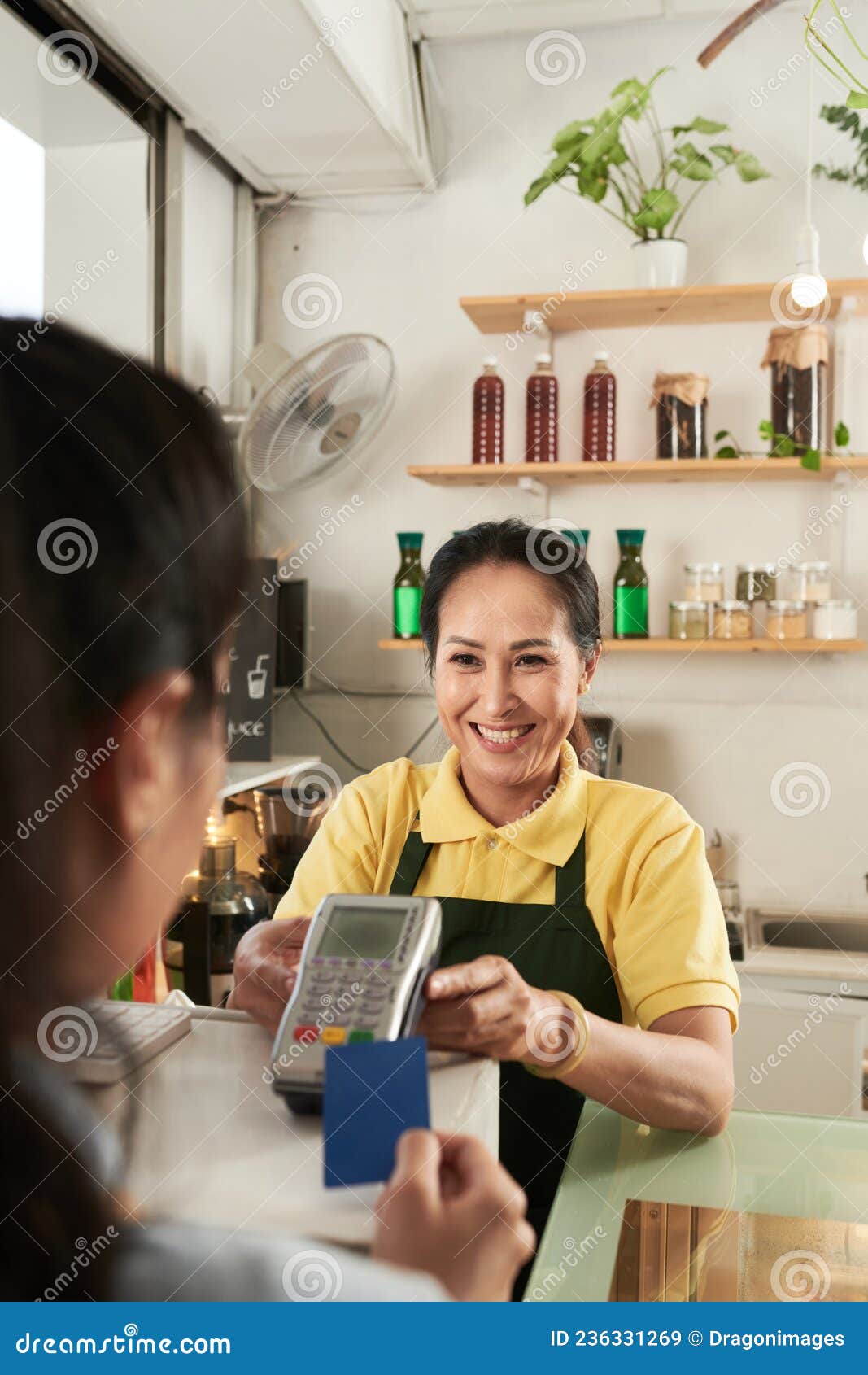 Cafe Worker Accepting Payment Stock Image - Image of women, smiling ...