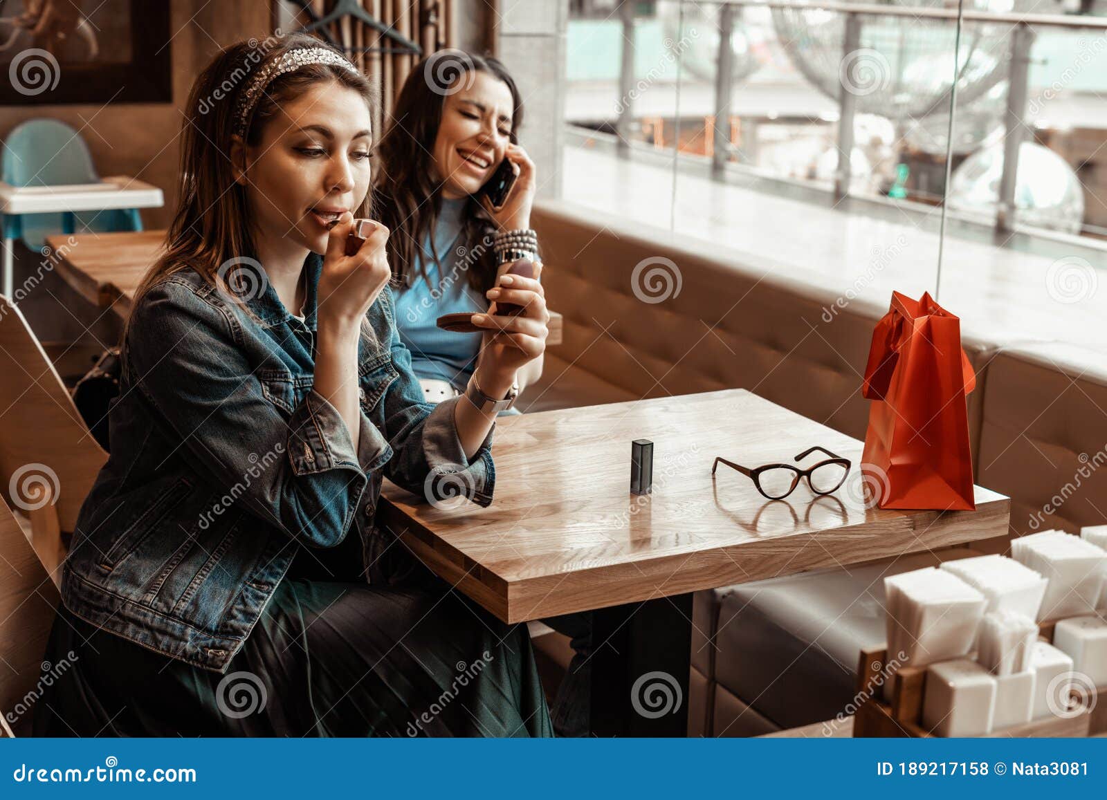 Cafes And Bars Two Girls Are Sitting At A Cafe Table Discussion Of