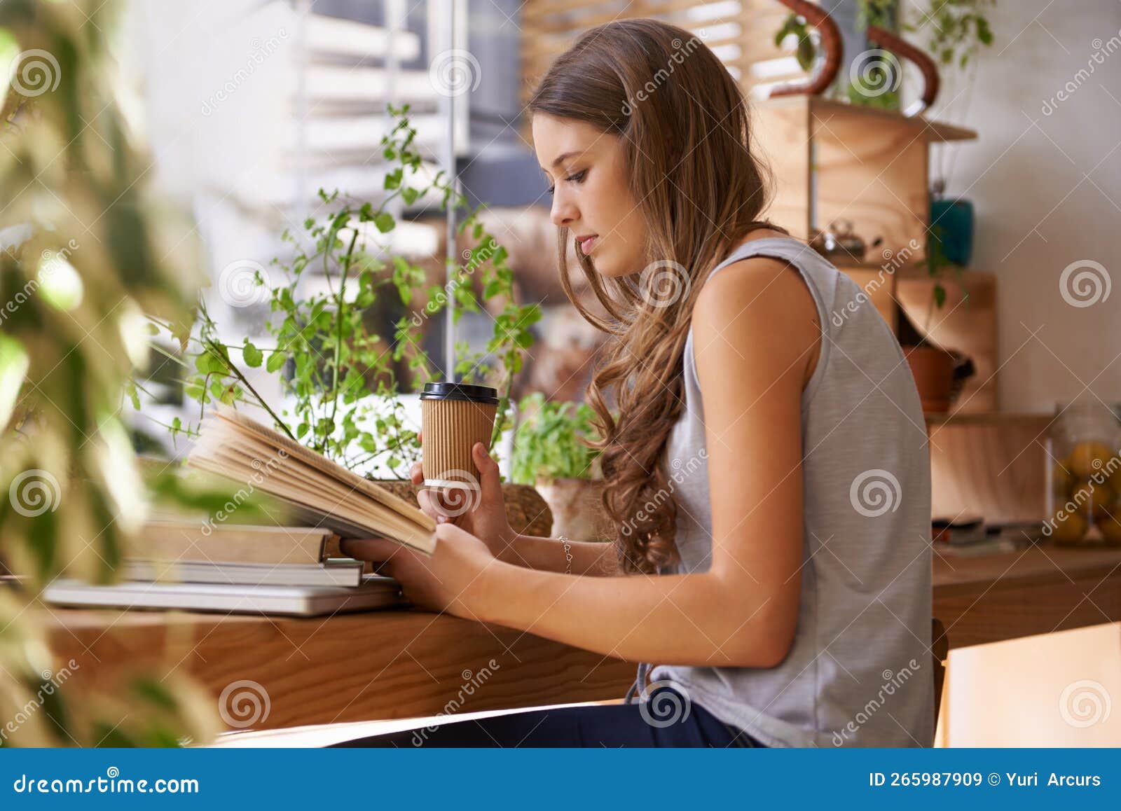 Caffeine-boosted Studying in Progress...a Young Woman Reading a Book in ...