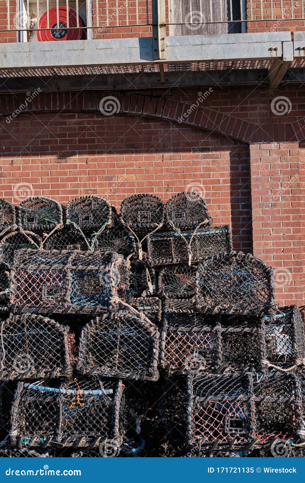 Cages Stacked on Top of Each Other in Front of a Brick Wall Stock Image ...