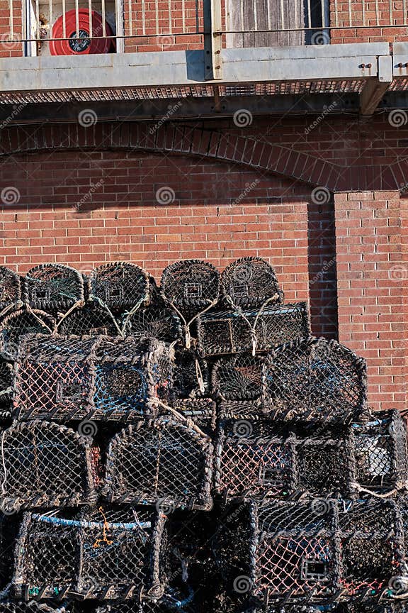 Cages Stacked on Top of Each Other in Front of a Brick Wall Stock Image ...