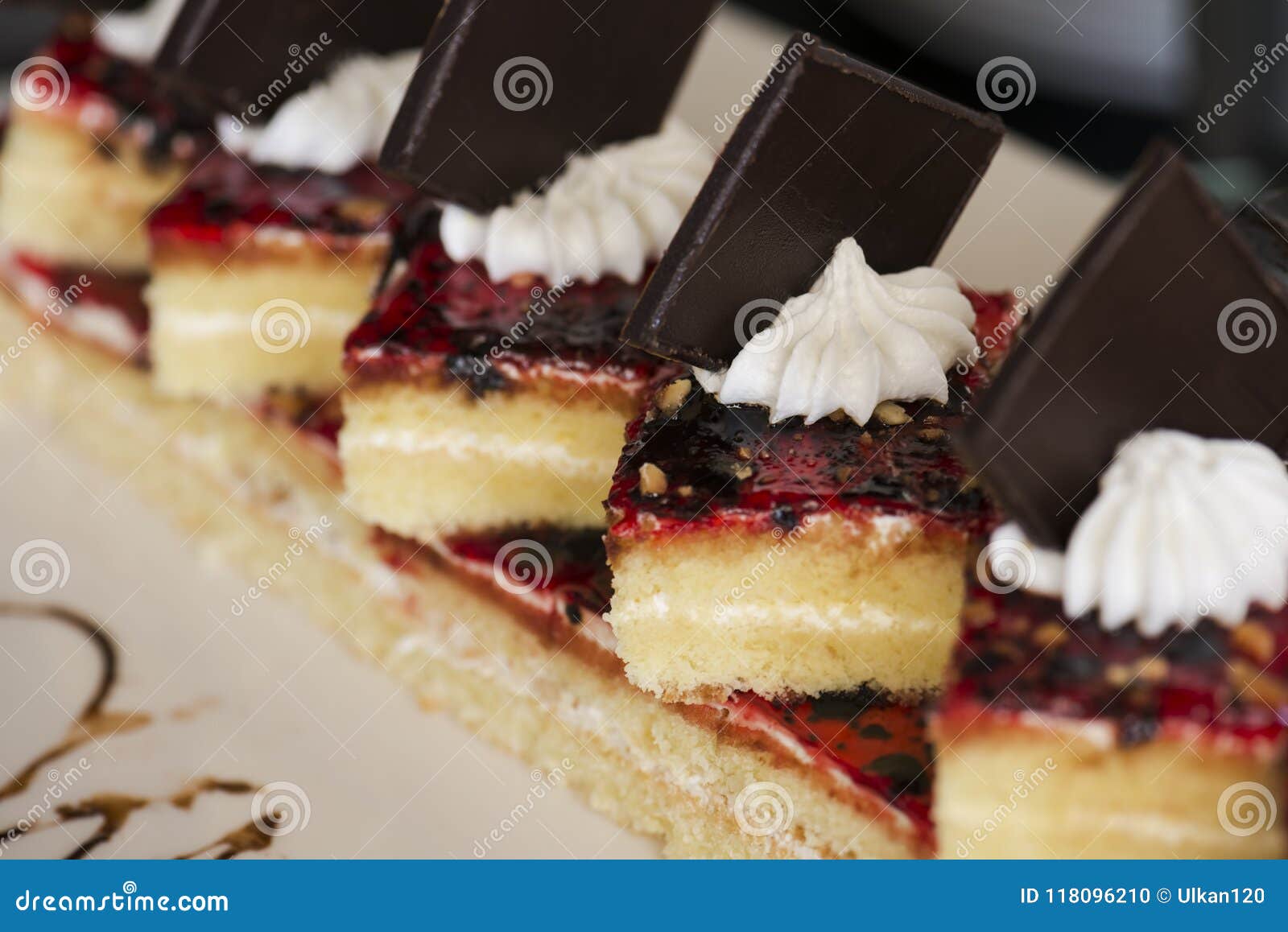 The Cake with Jam is Decorated with Cream and Pieces of Chocolate on a ...