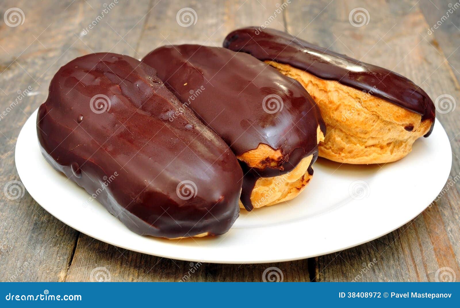 Cakes eclairs in the plate stock photo. Image of delicious - 38408972