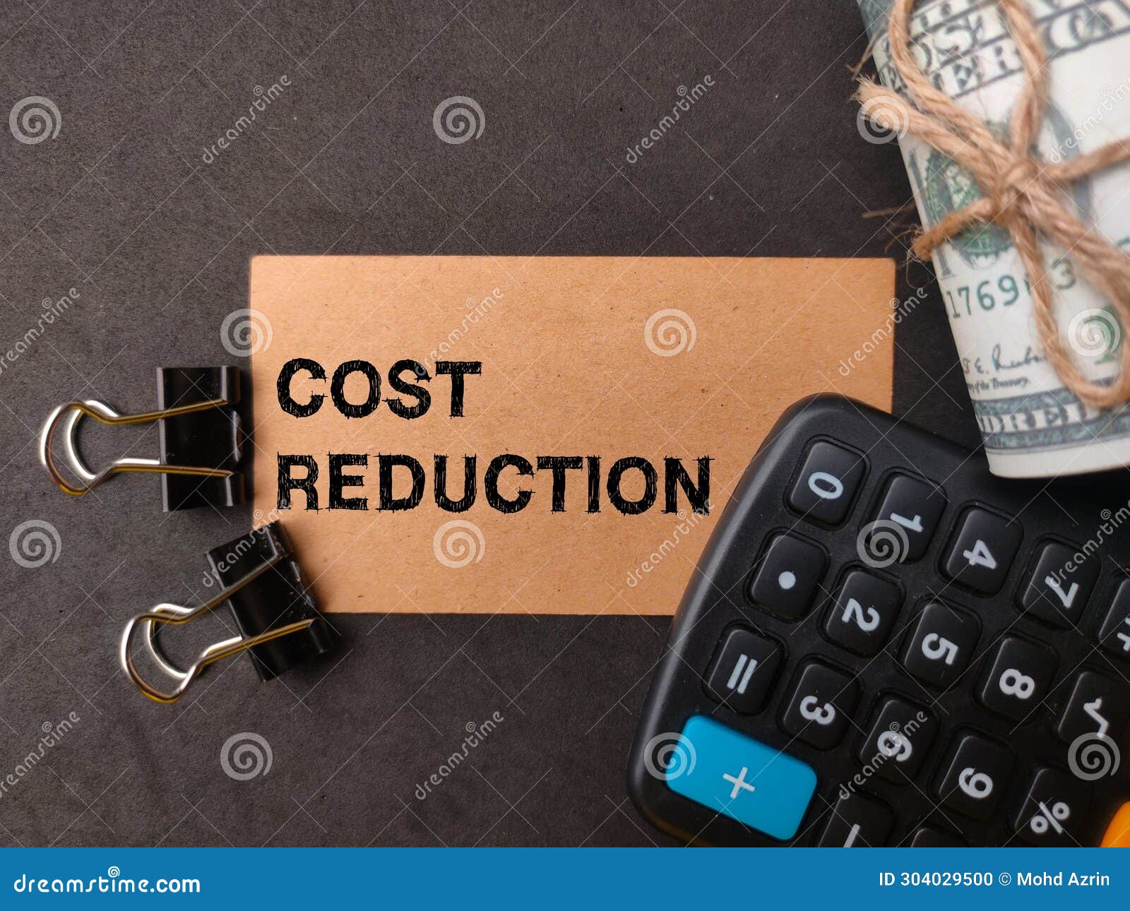 Calculator,banknotes and Brown Card with Text COST REDUCTION Stock ...