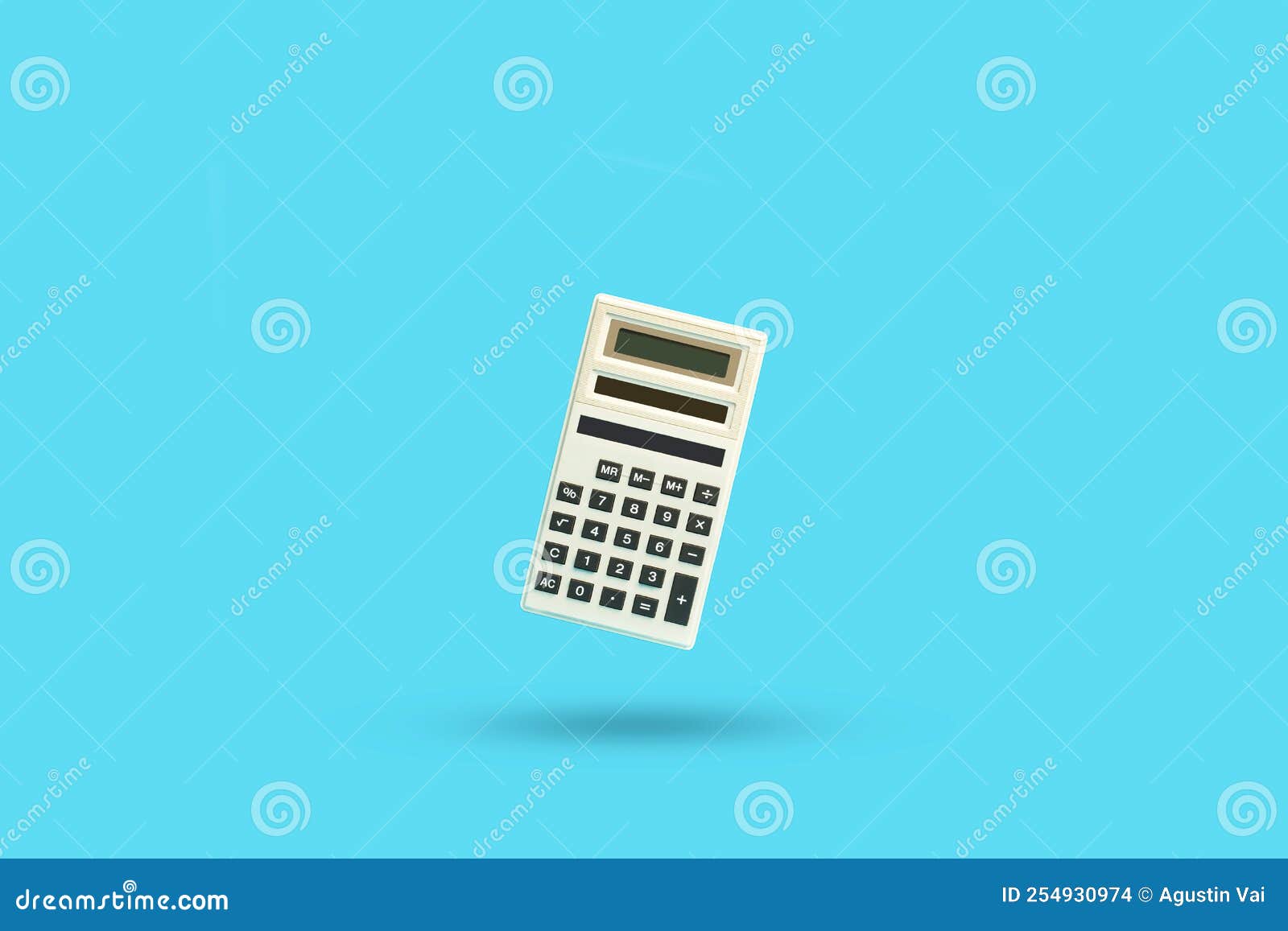 A Calculator Floating on a Blue Background Stock Photo - Image of ...