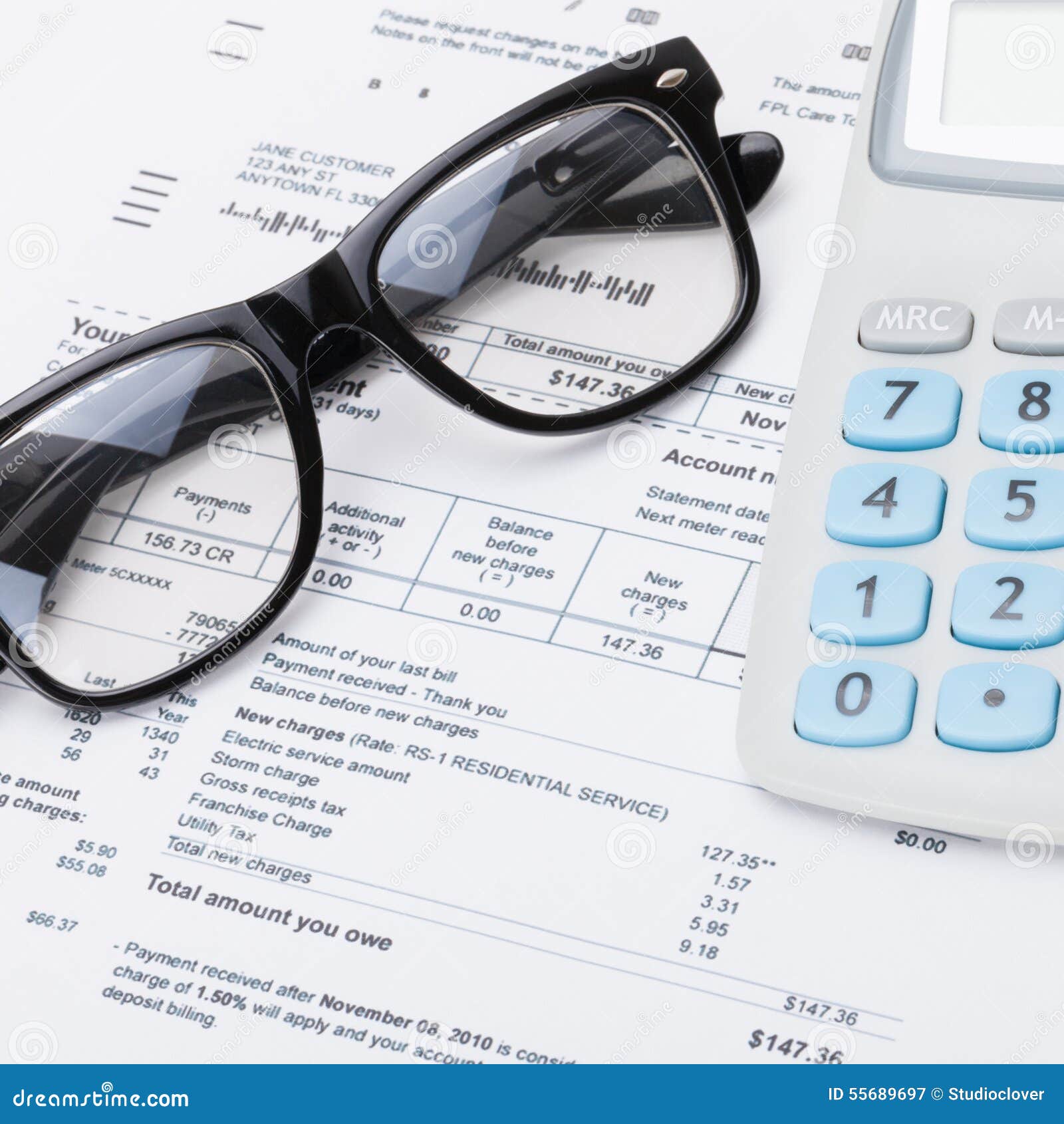 Calculator and Glasses with Utility Bill Under it - Close Up Stock ...