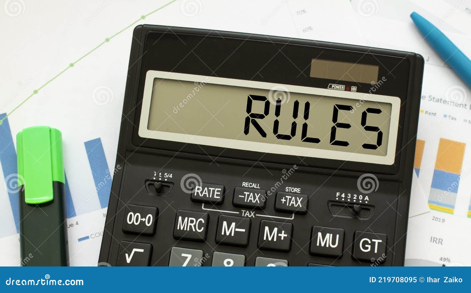 A Calculator Labeled RULES Lies on Financial Documents in the Office ...