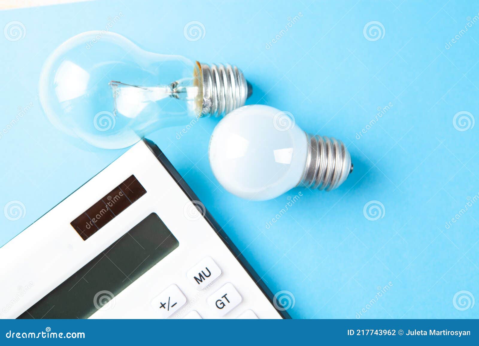 Calculator and light bulbs stock photo. Image of electric - 217743962