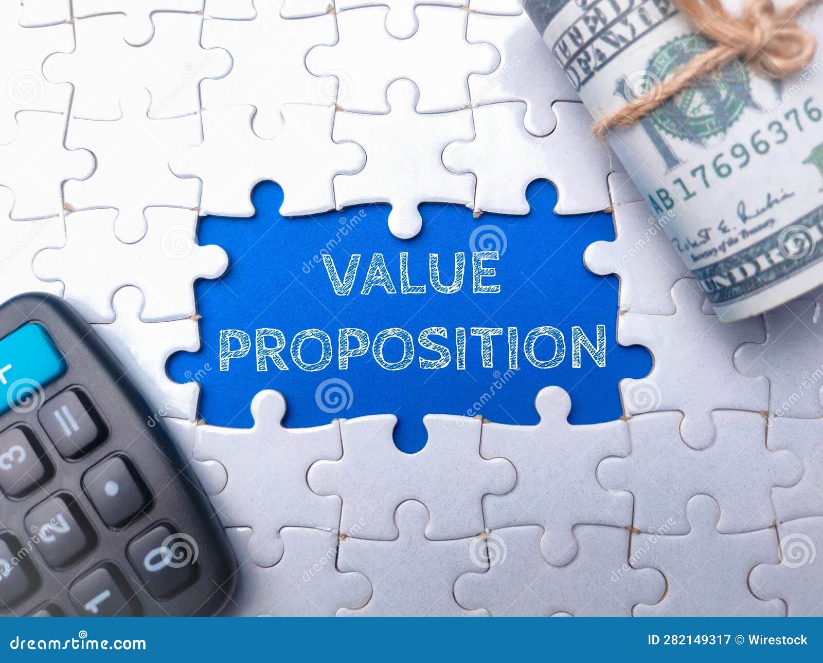 Calculator and Puzzle Pieces with the Word Value Proposition Printed on ...