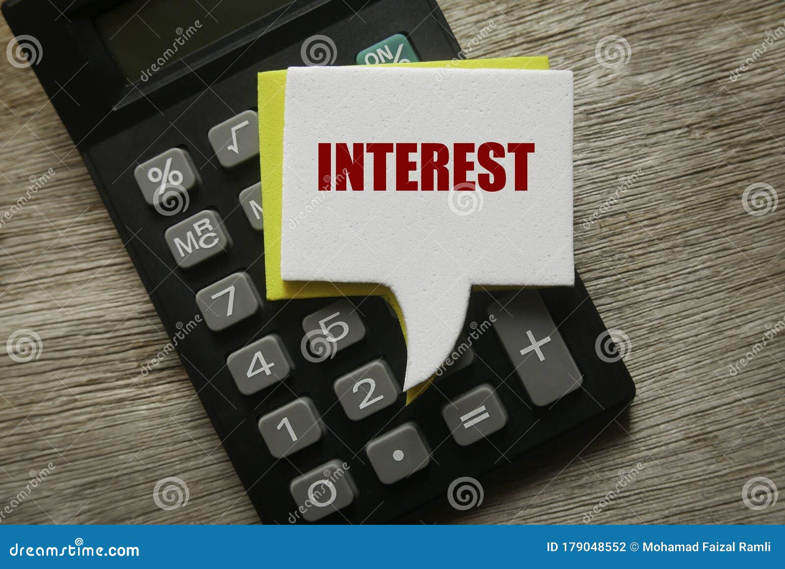 Calculator and Speech Bubbles Written with Interest on Wooden ...